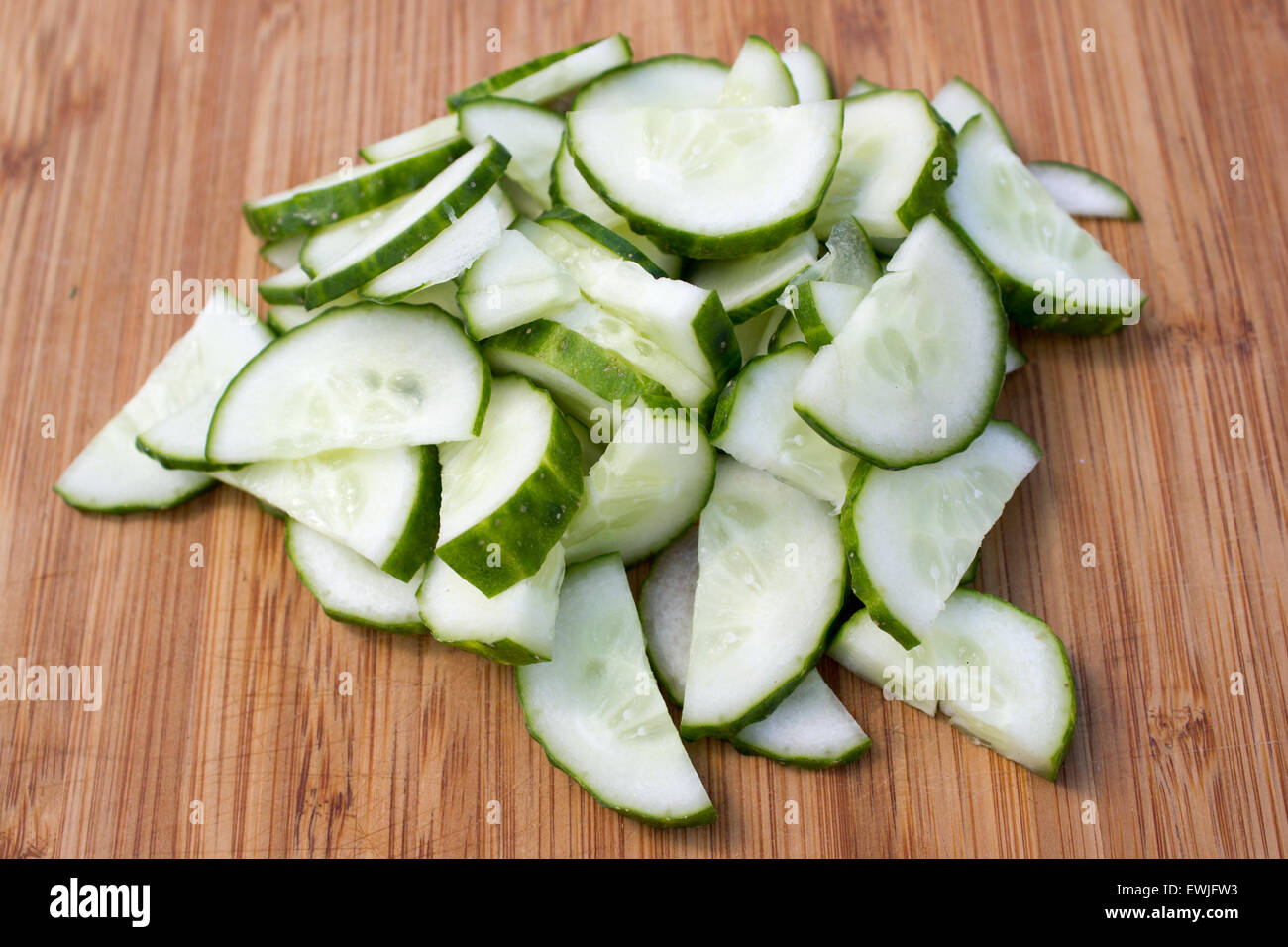 sliced cucumber stack on wooden plate Stock Photo - Alamy