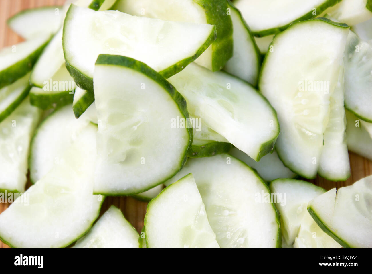sliced cucumber stack on wooden plate Stock Photo - Alamy