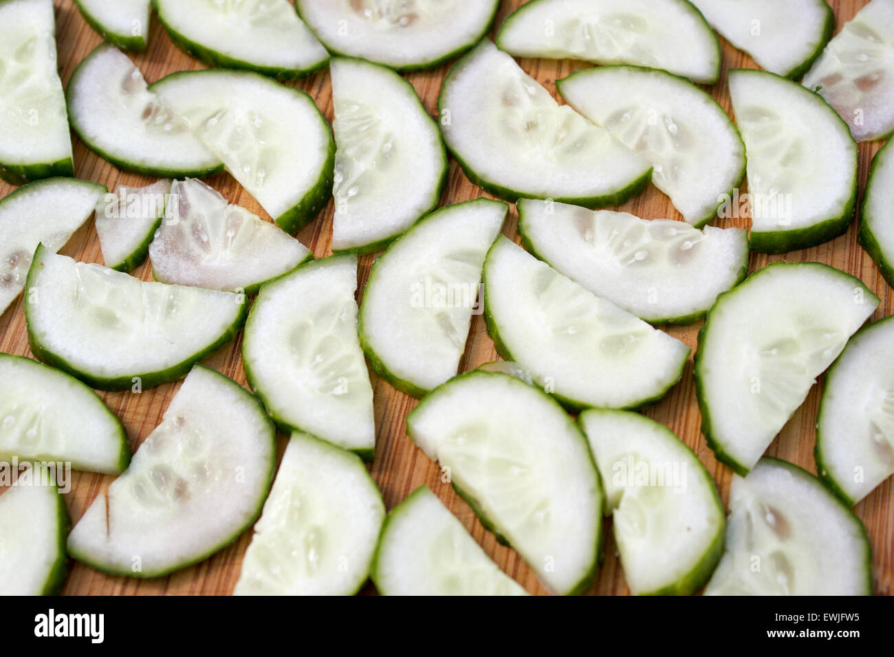 sliced cucumber stack on wooden plate Stock Photo - Alamy