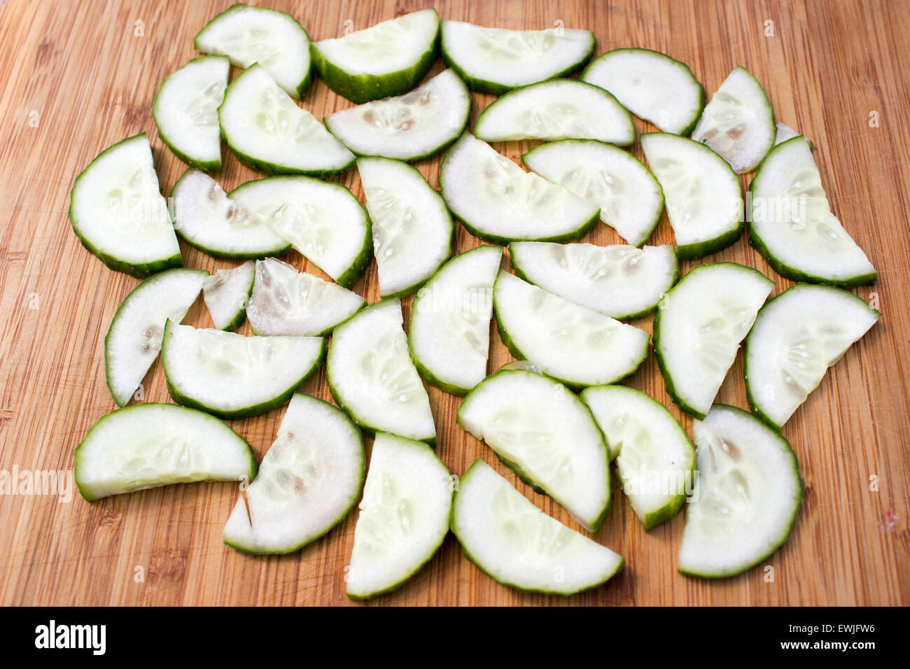 sliced cucumber stack on wooden plate Stock Photo - Alamy