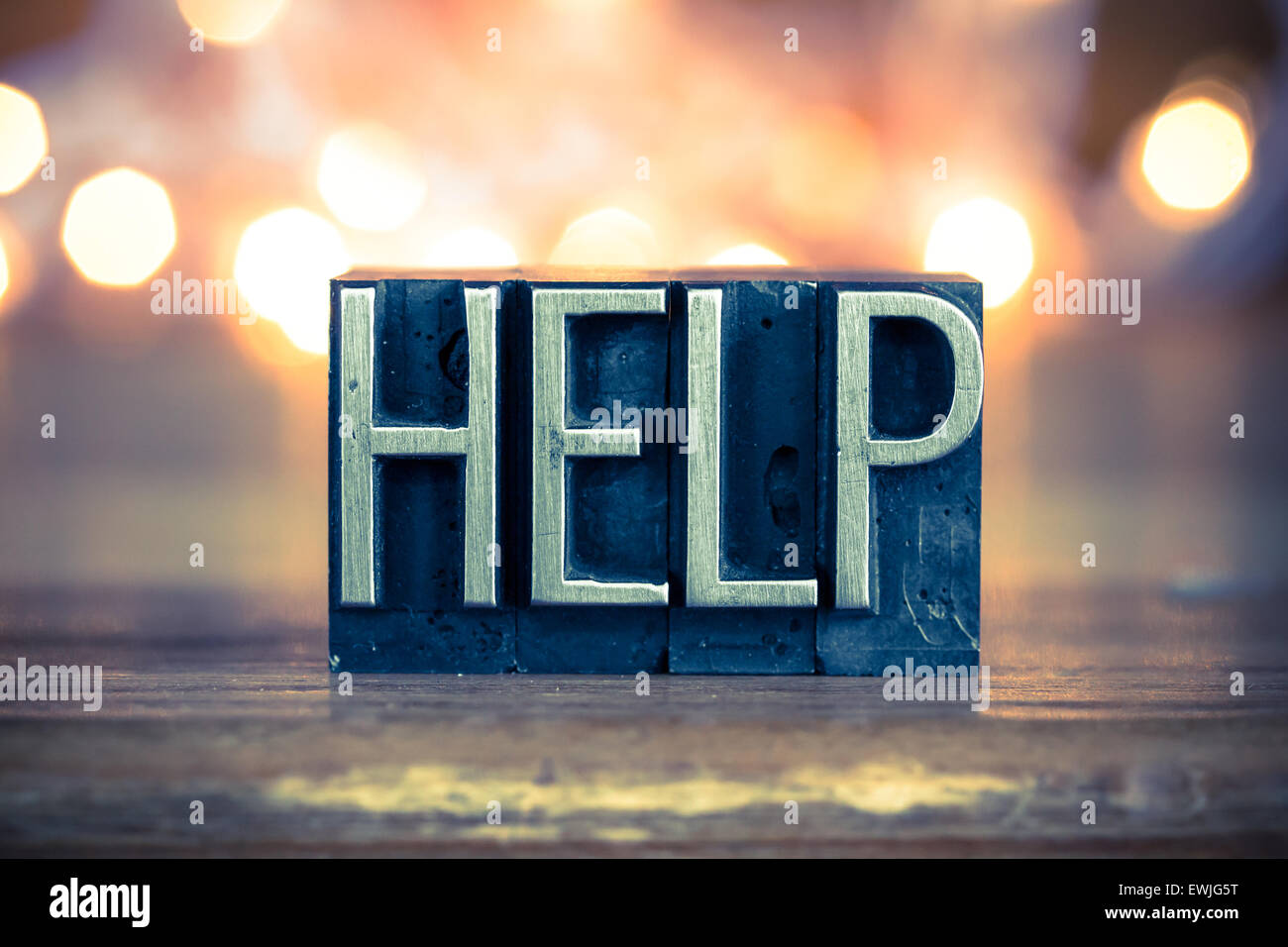 The word HELP written in vintage metal letterpress type on a soft ...