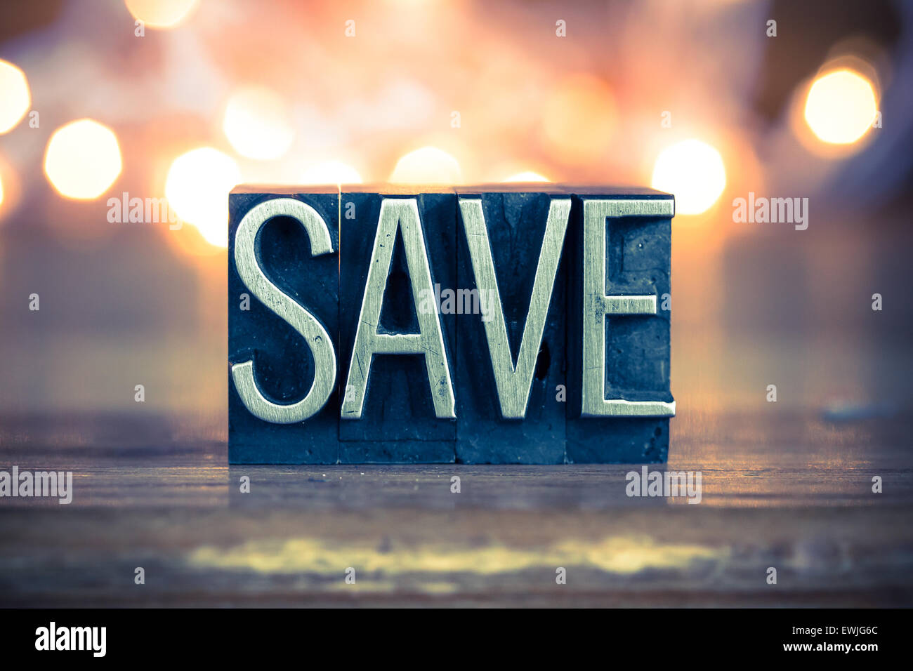 The word SAVE written in vintage metal letterpress type on a soft ...
