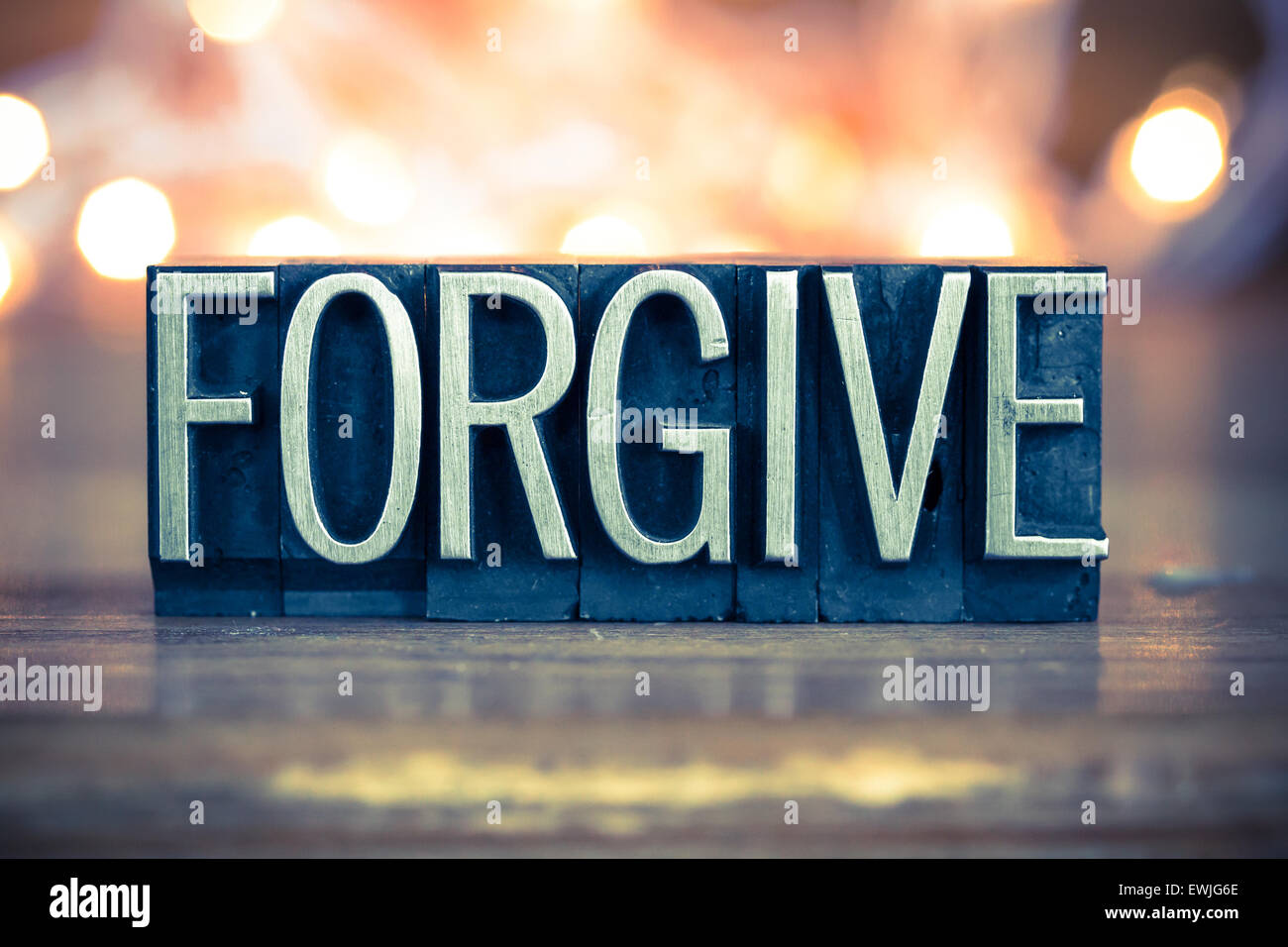 The word FORGIVE written in vintage metal letterpress type on a soft ...