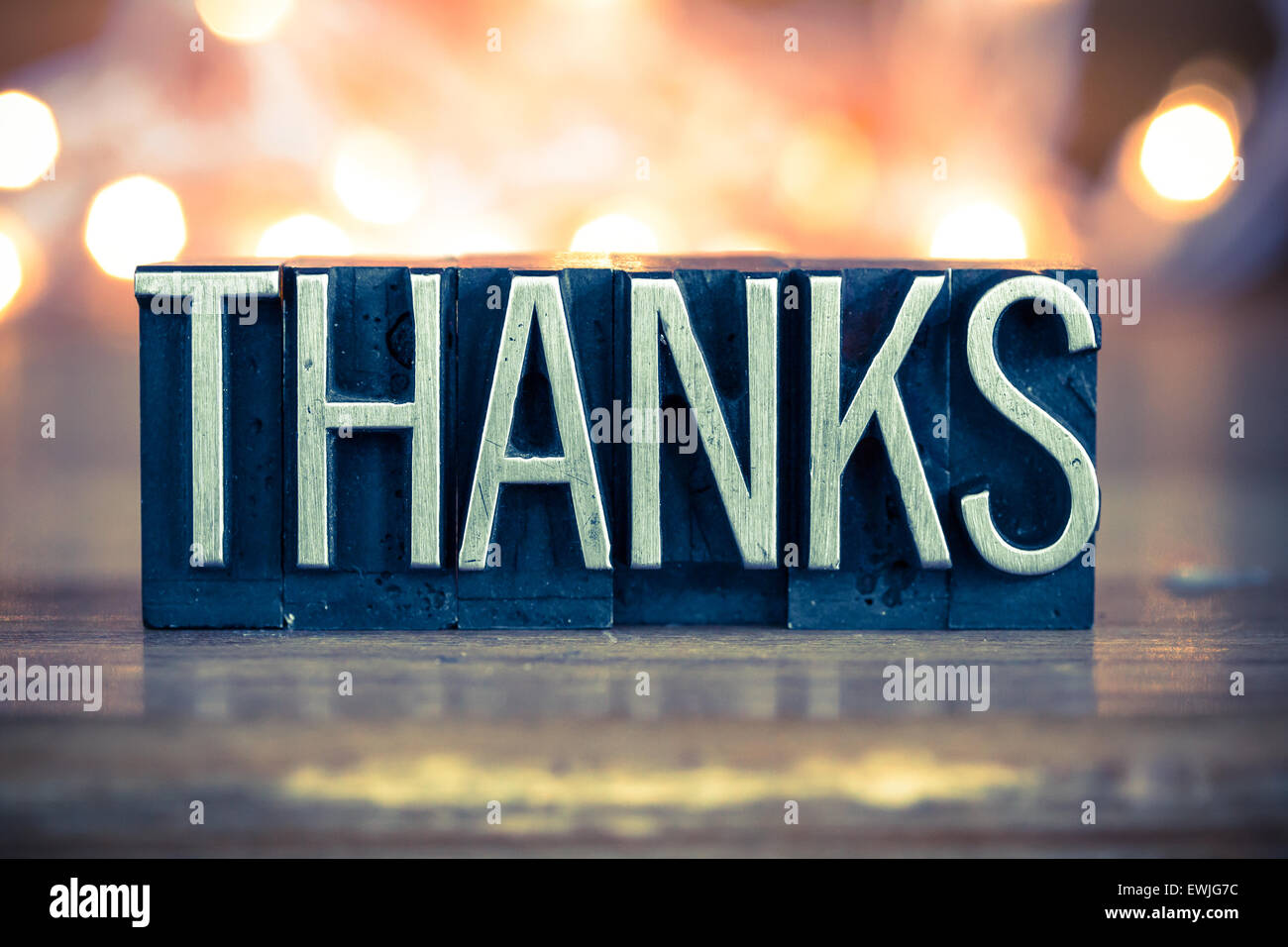 The word THANKS written in vintage metal letterpress type on a soft ...