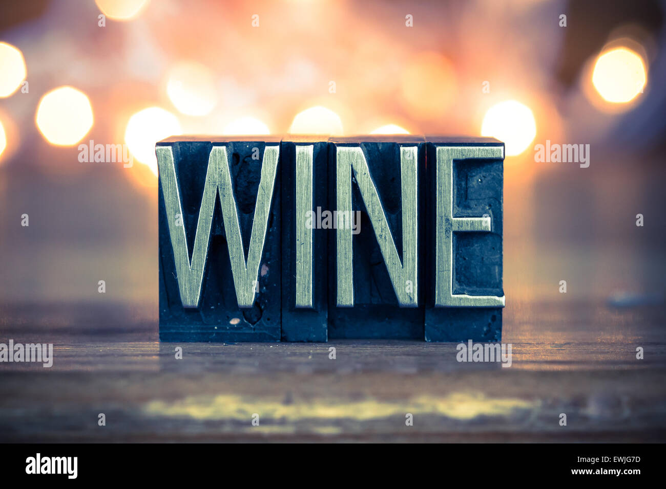 The word WINE written in vintage metal letterpress type on a soft ...
