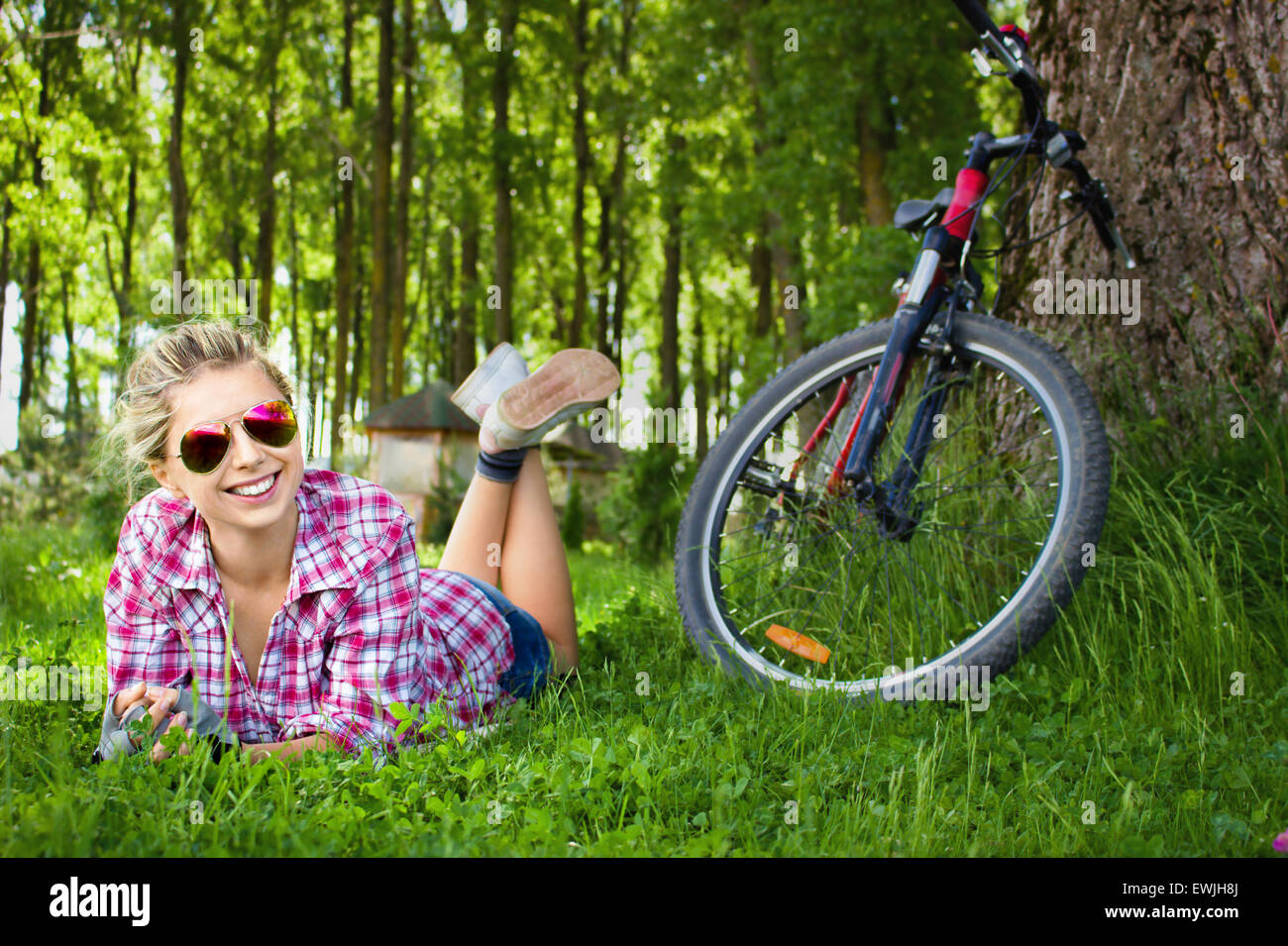 Young cyclist relaxation lying in the fresh green grass Stock Photo - Alamy
