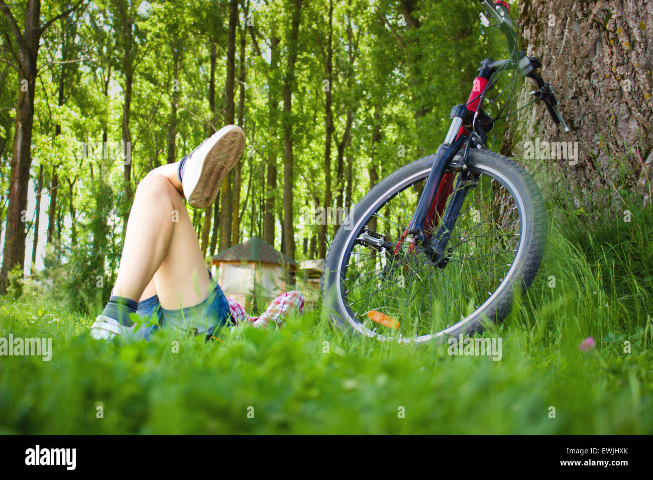 Young cyclist relaxation lying in the fresh green grass Stock Photo - Alamy