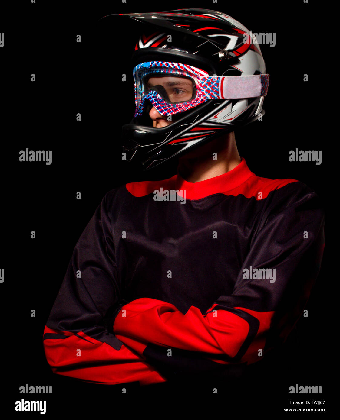 Cyclist man in bicycle uniform with crossed arms on black background ...