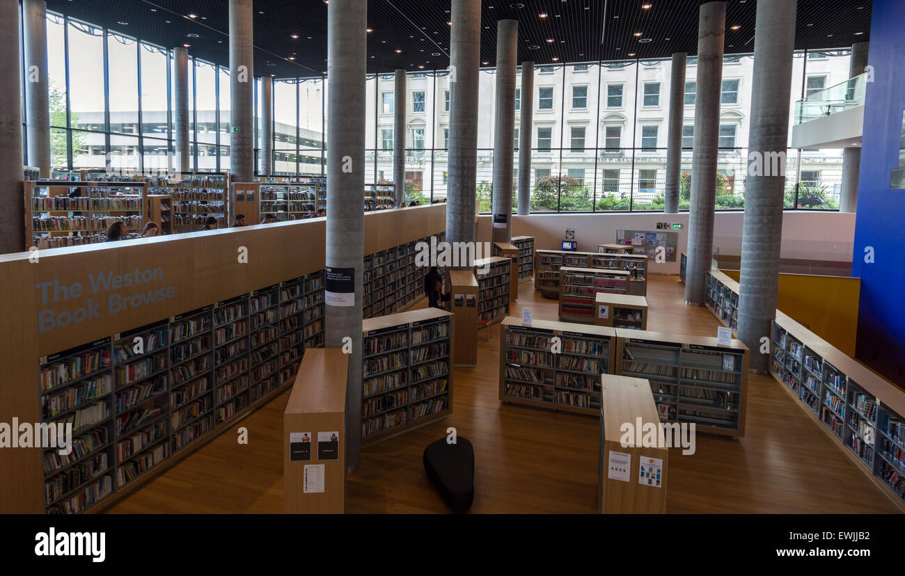 Futuristic interior of the Library of Birmingham with shelves of books ...