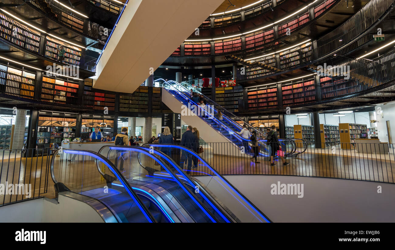 Futuristic interior of the Library of Birmingham with shelves of books ...