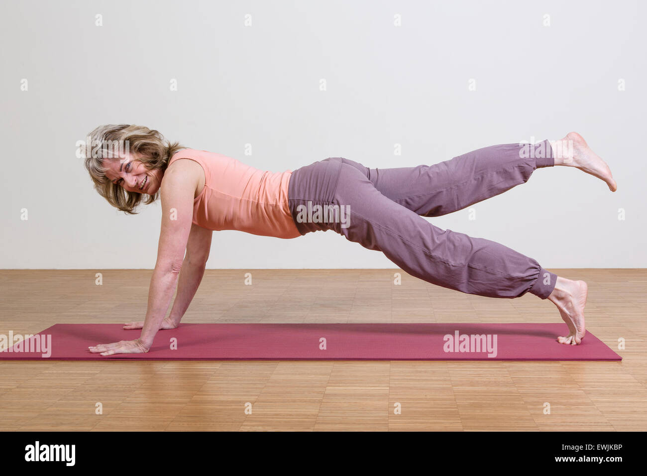female yoga coach shows exercise Stock Photo - Alamy