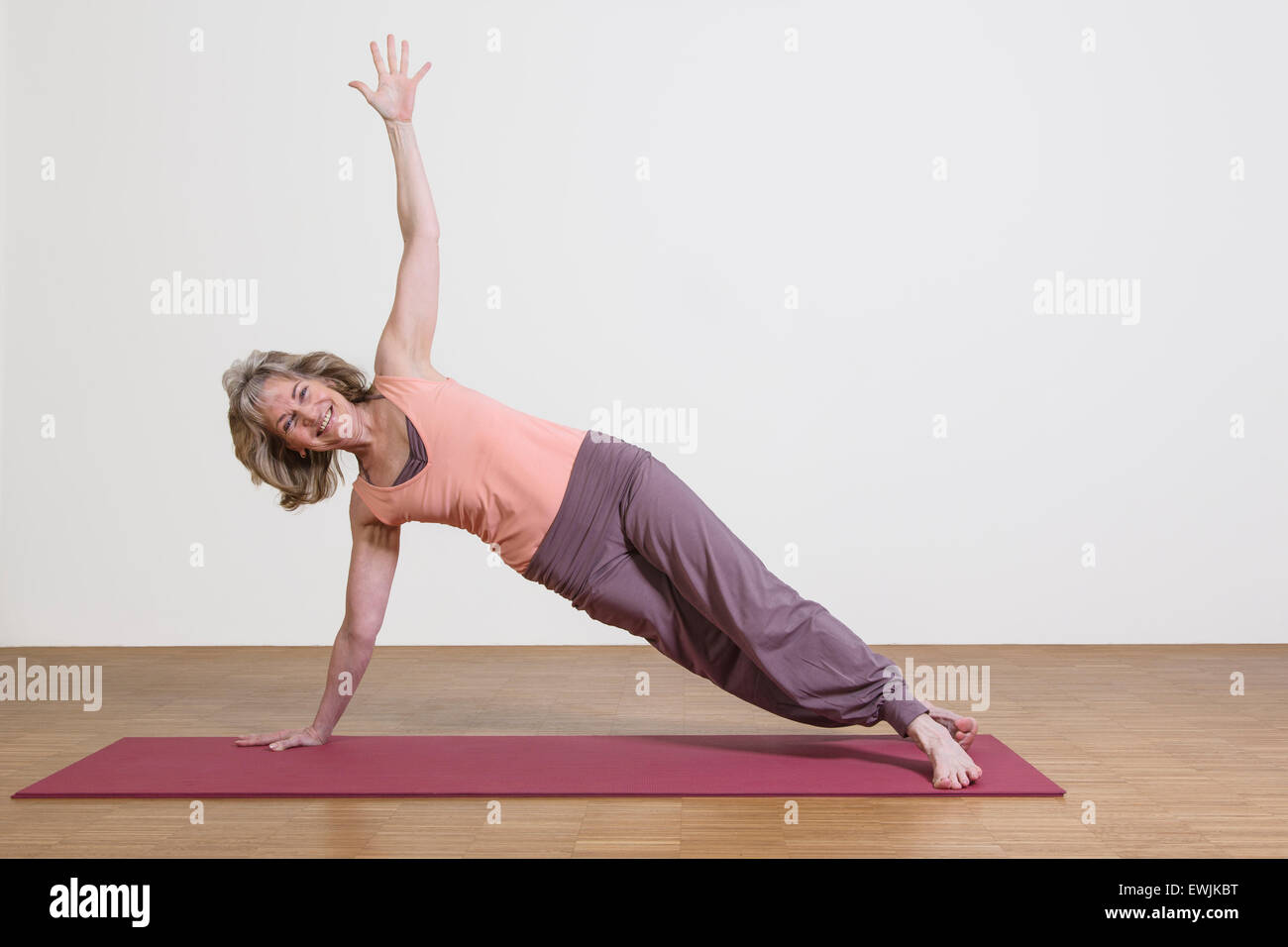 female yoga coach shows exercise Stock Photo - Alamy