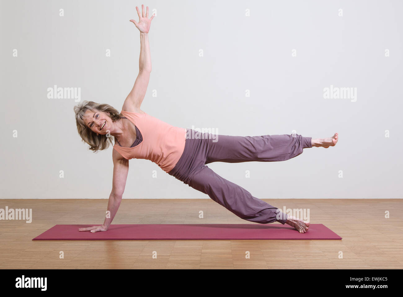 female yoga coach shows exercise Stock Photo - Alamy
