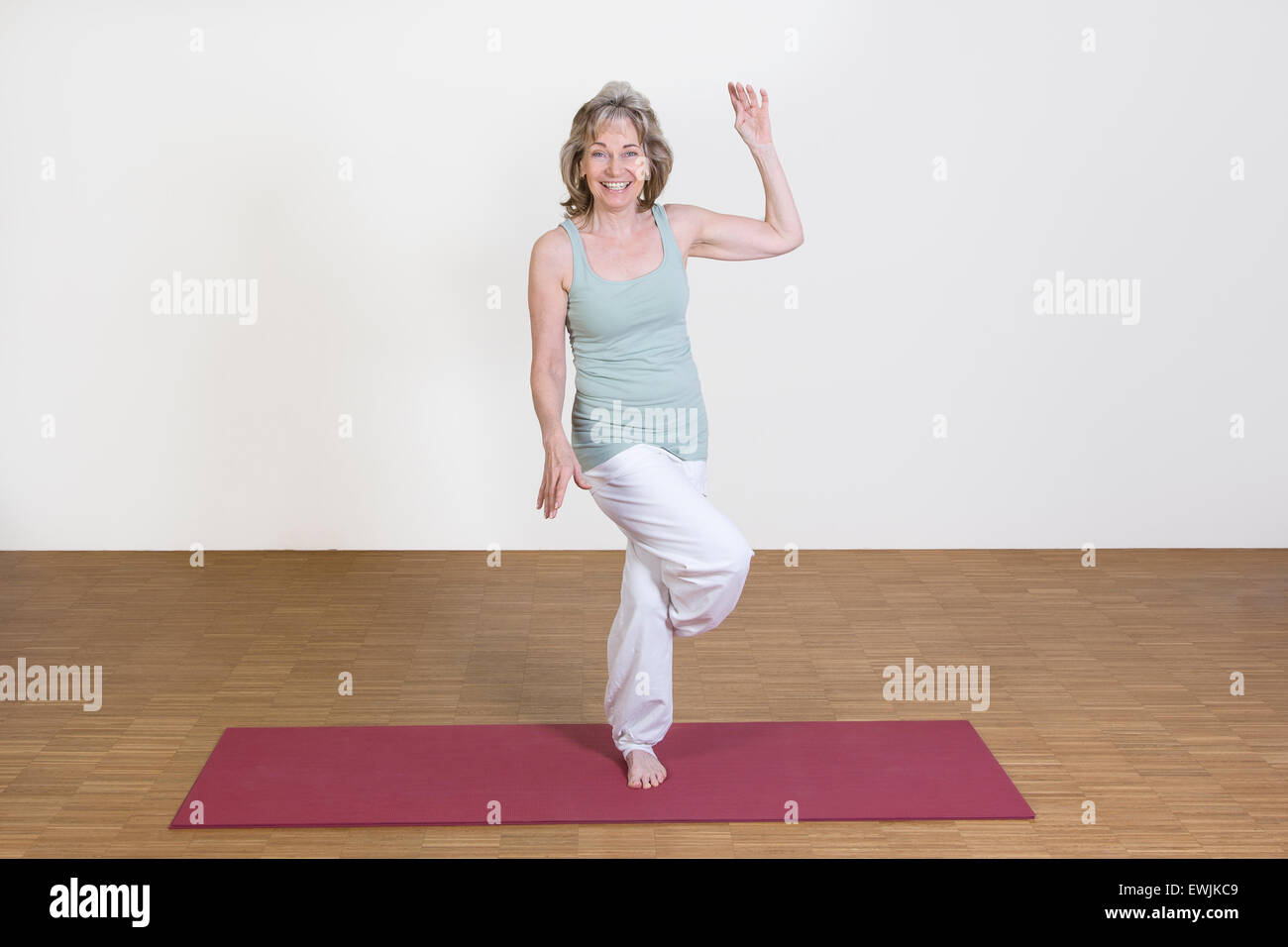 female yoga coach shows exercise Stock Photo - Alamy
