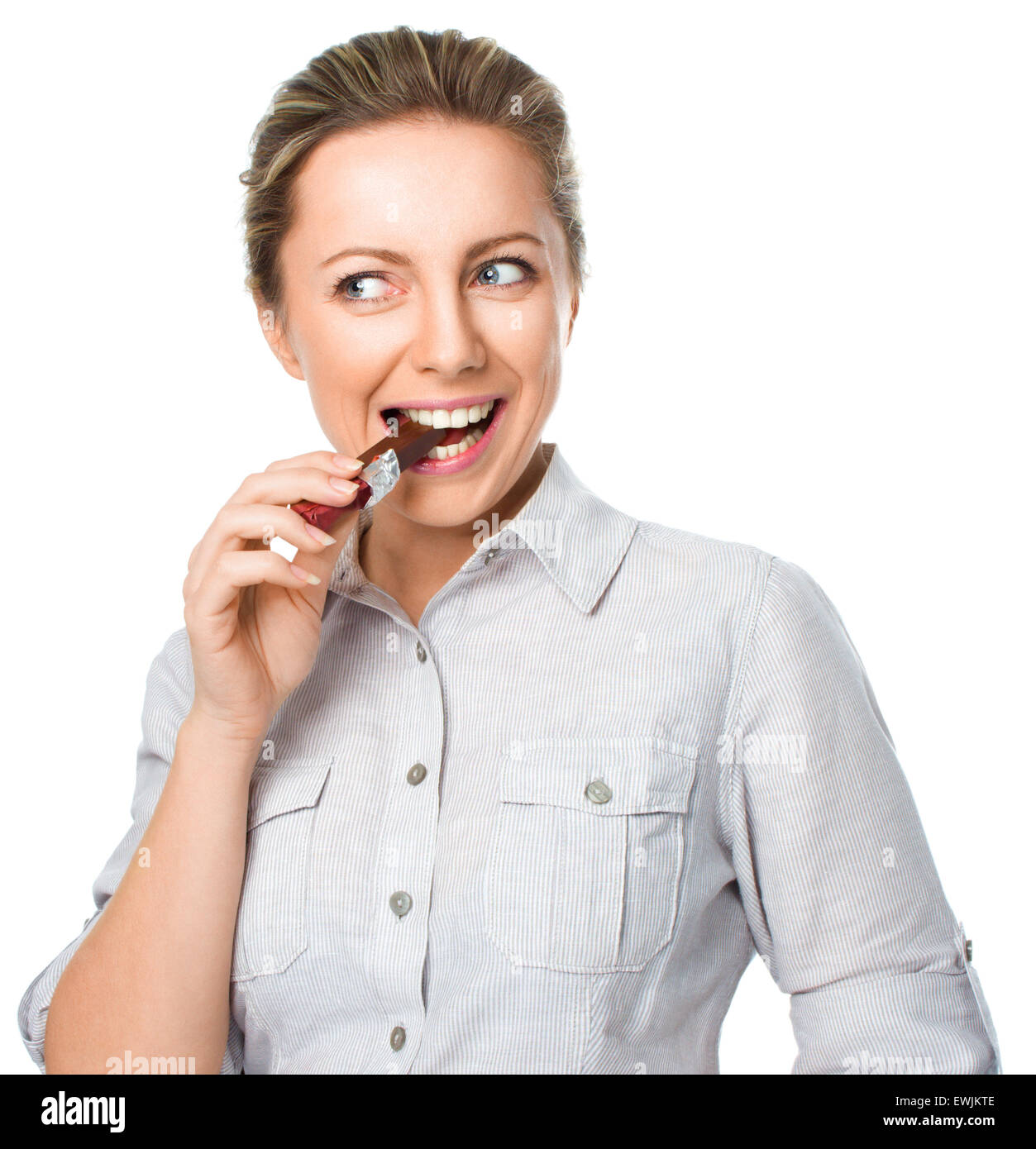 portrait of a young woman biting chocolate isolated on white background ...