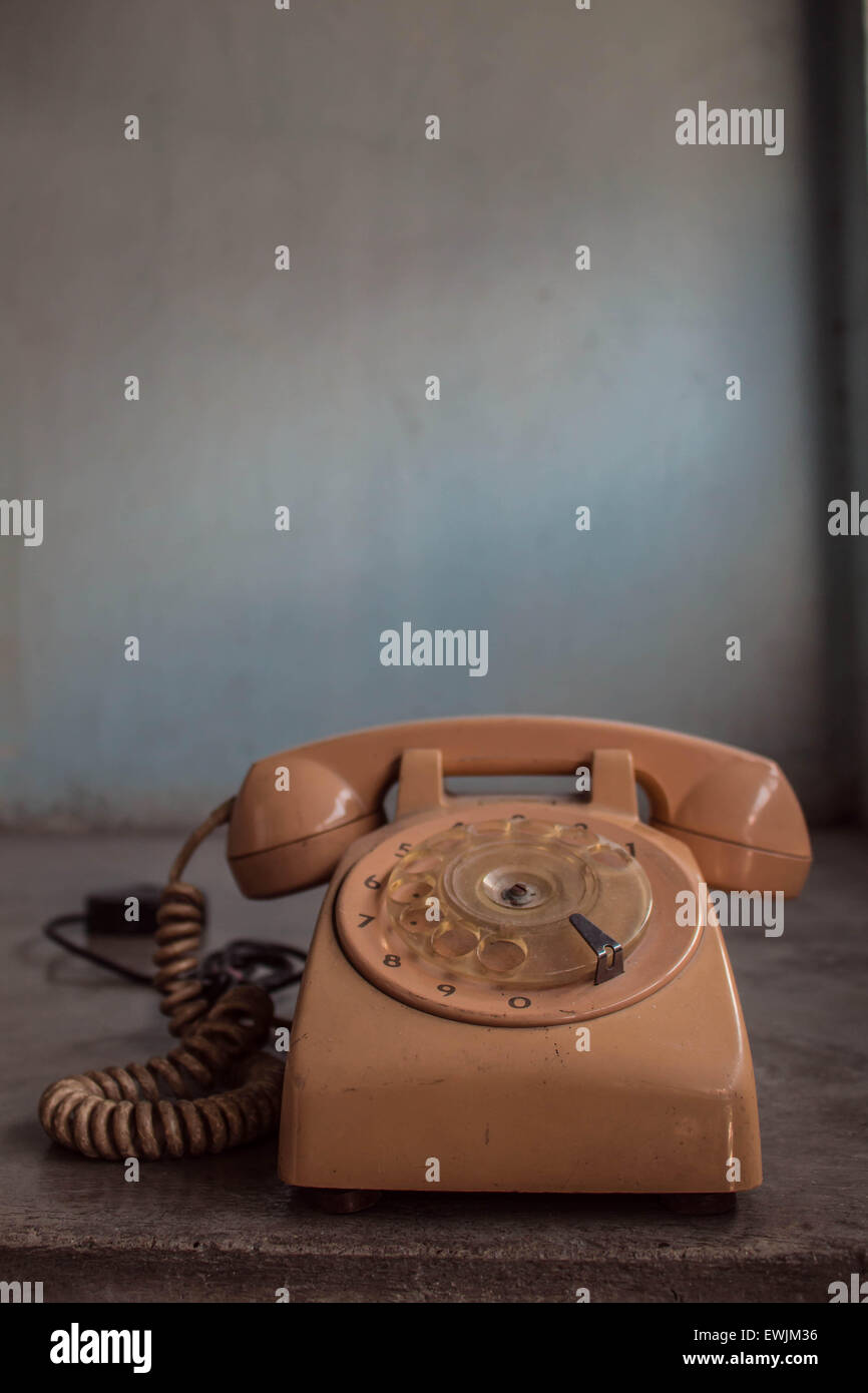 Phone old on concrete background with of vintage Stock Photo - Alamy