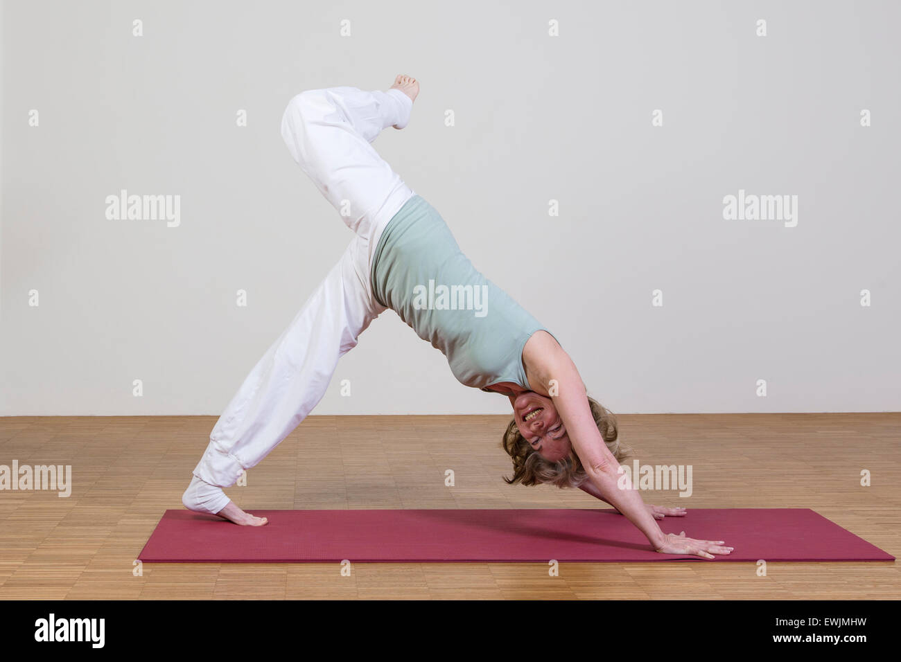 female yoga coach shows exercise Stock Photo - Alamy