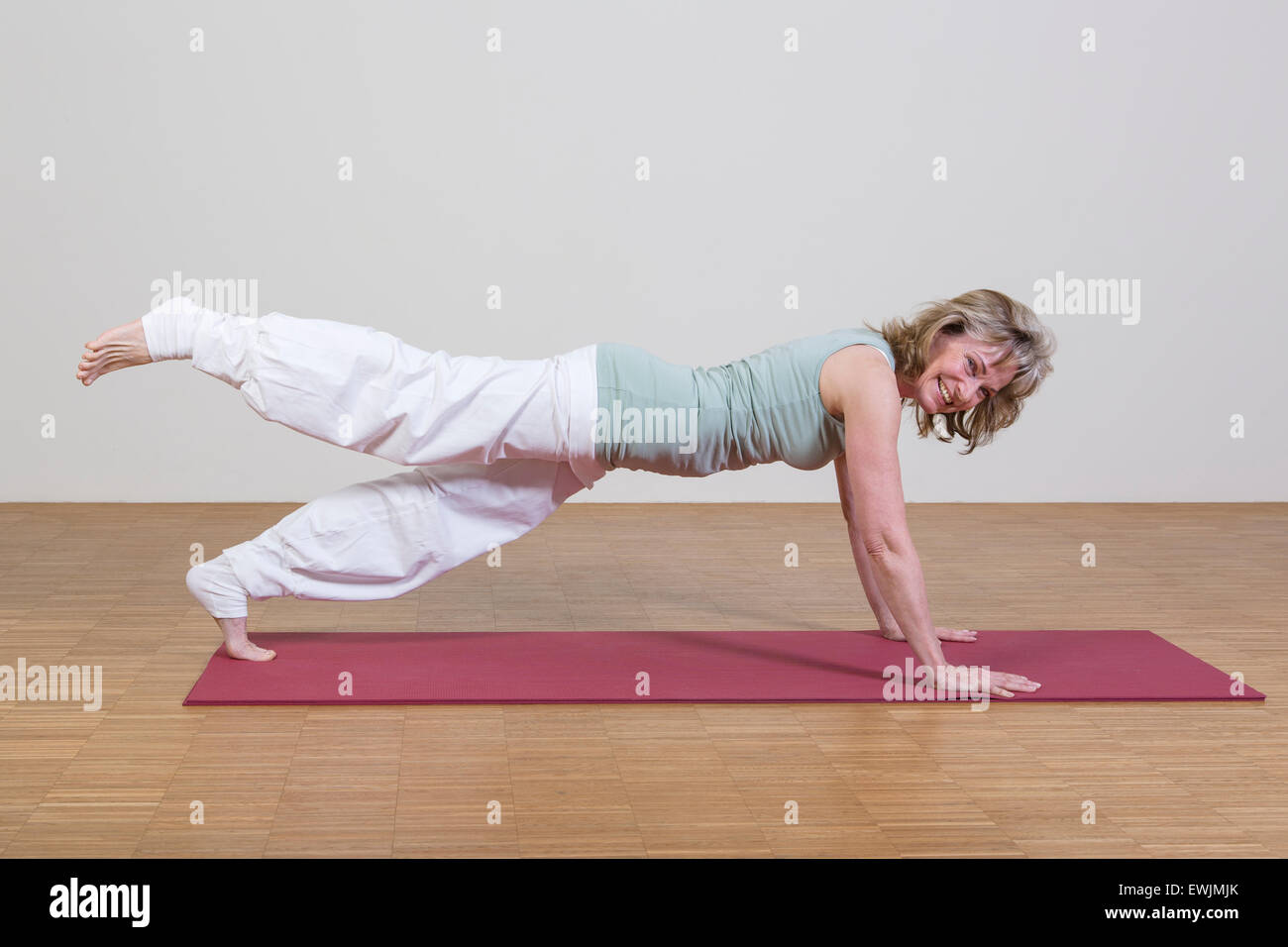 female yoga coach shows exercise Stock Photo - Alamy