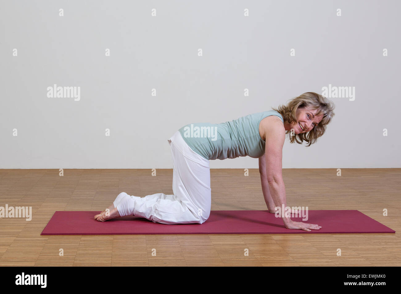 female yoga coach shows exercise Stock Photo - Alamy