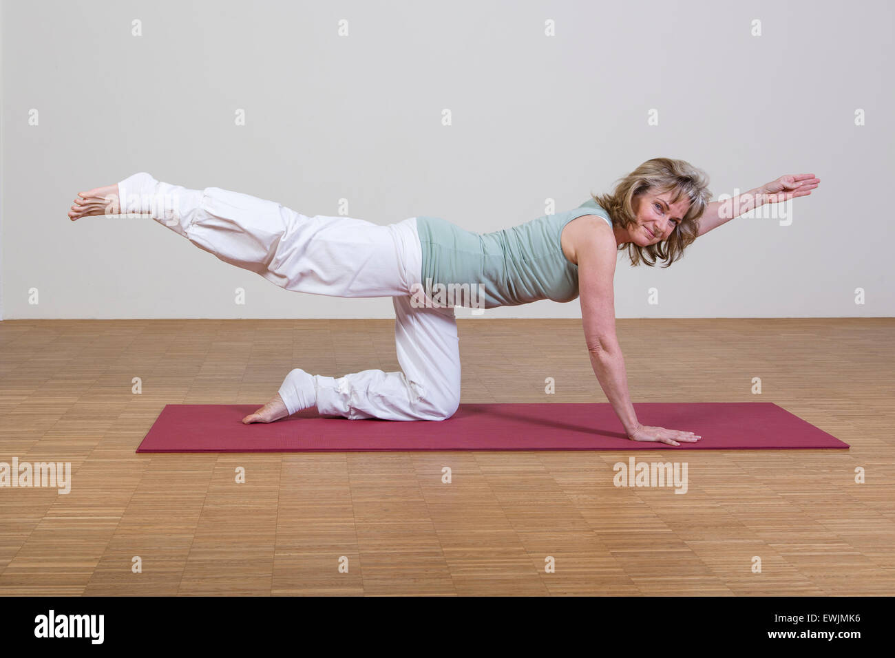 female yoga coach shows exercise Stock Photo - Alamy