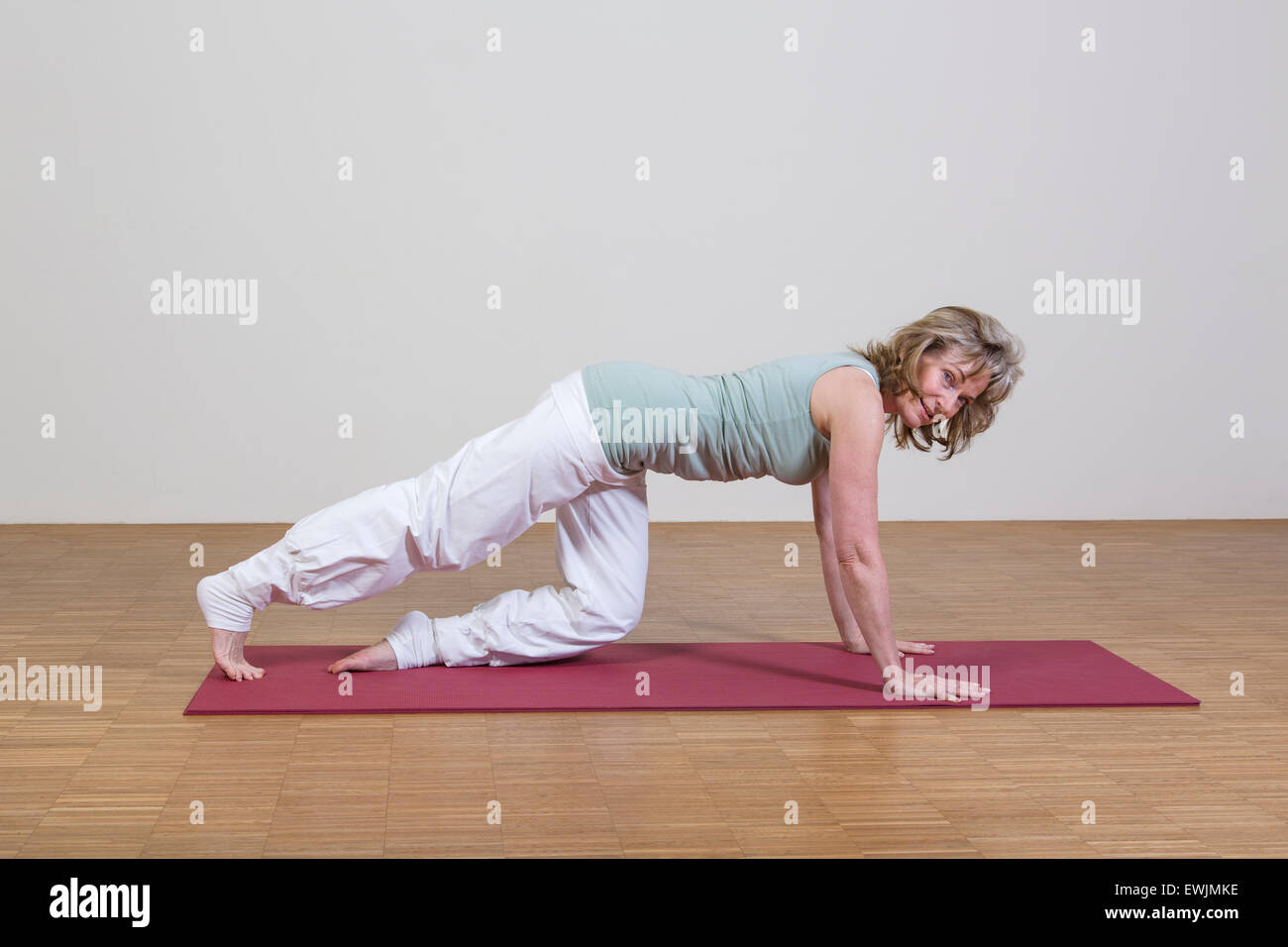 female yoga coach shows exercise Stock Photo - Alamy