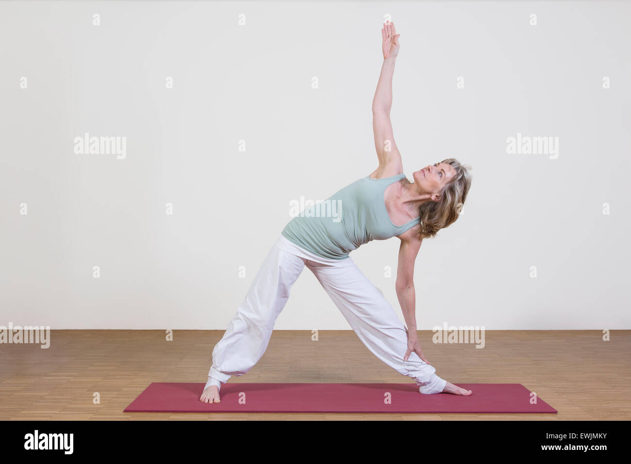 female yoga coach shows exercise Stock Photo - Alamy
