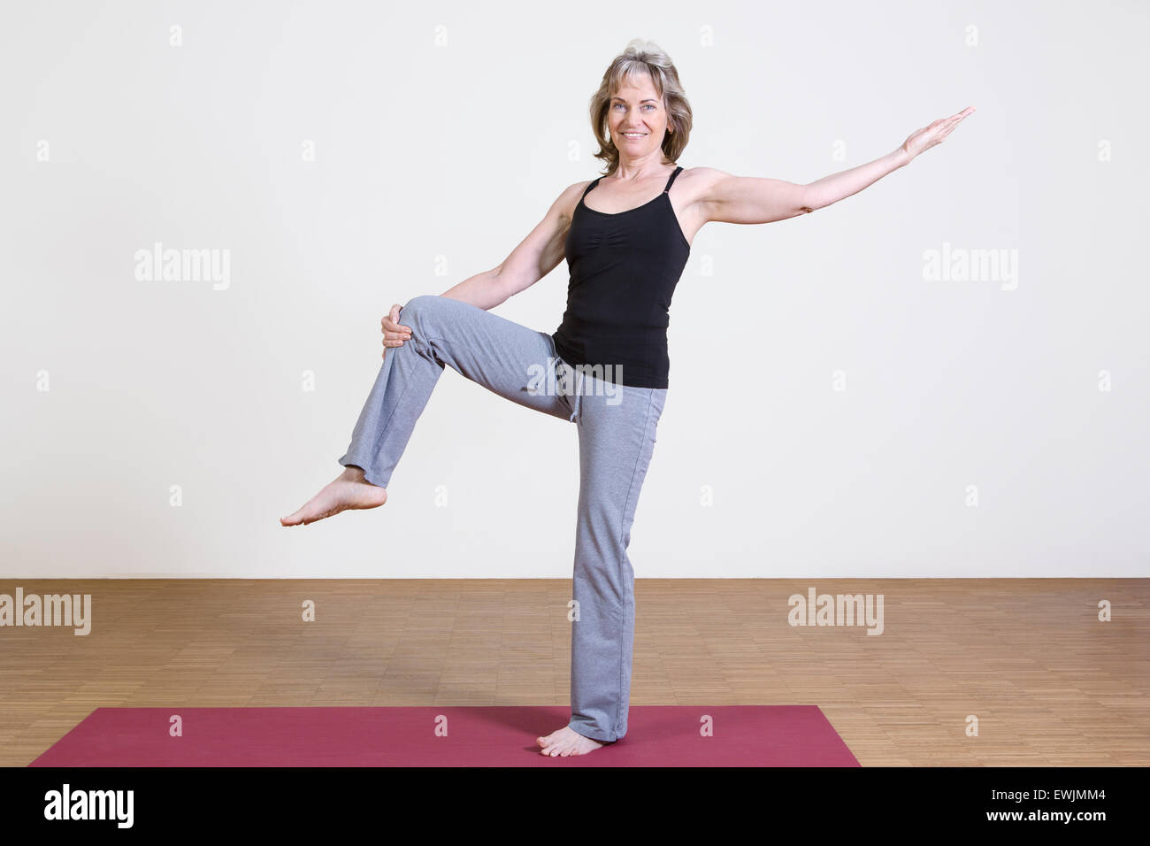 female yoga coach shows exercise Stock Photo - Alamy