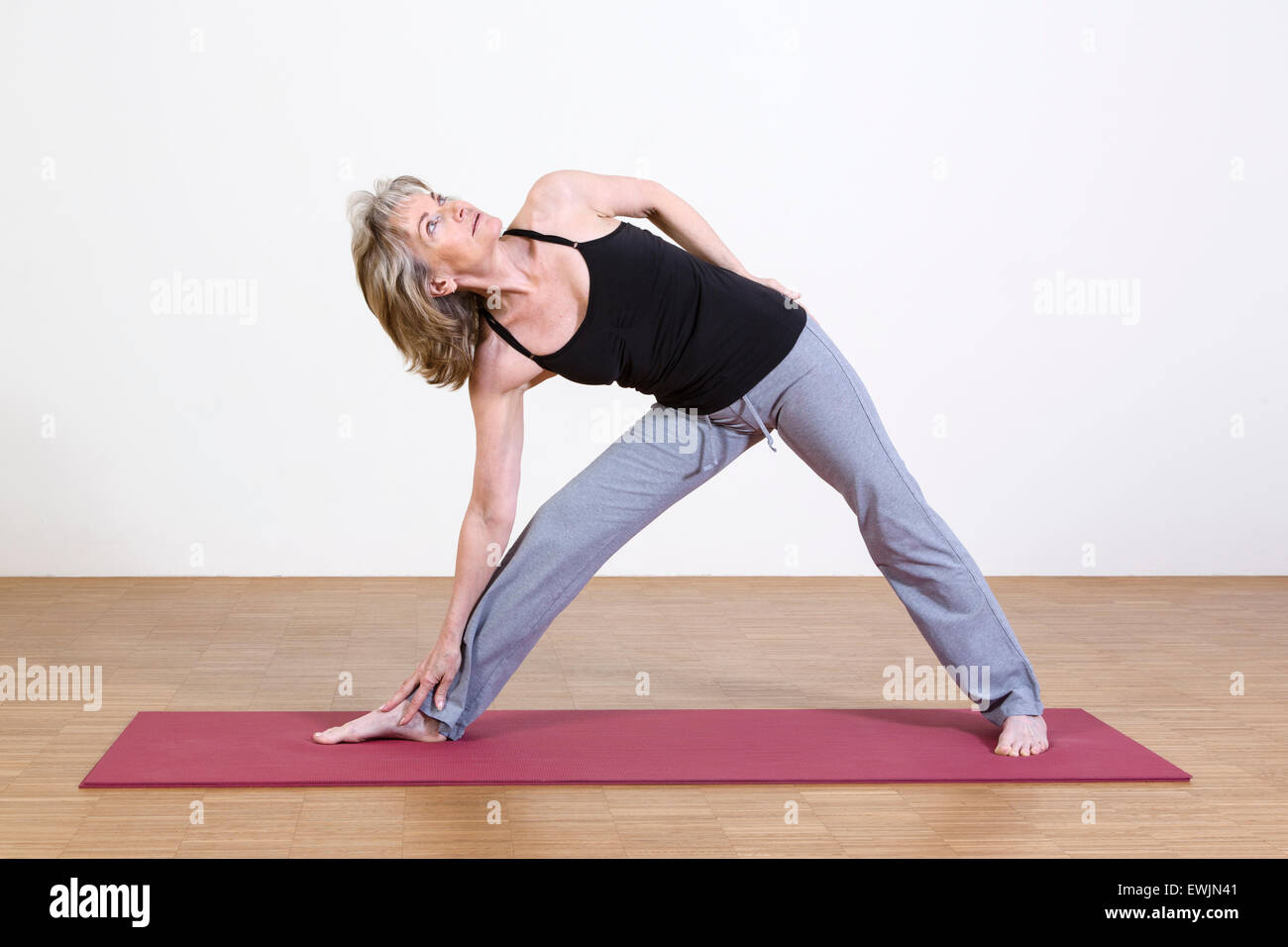 female yoga coach shows exercise Stock Photo - Alamy
