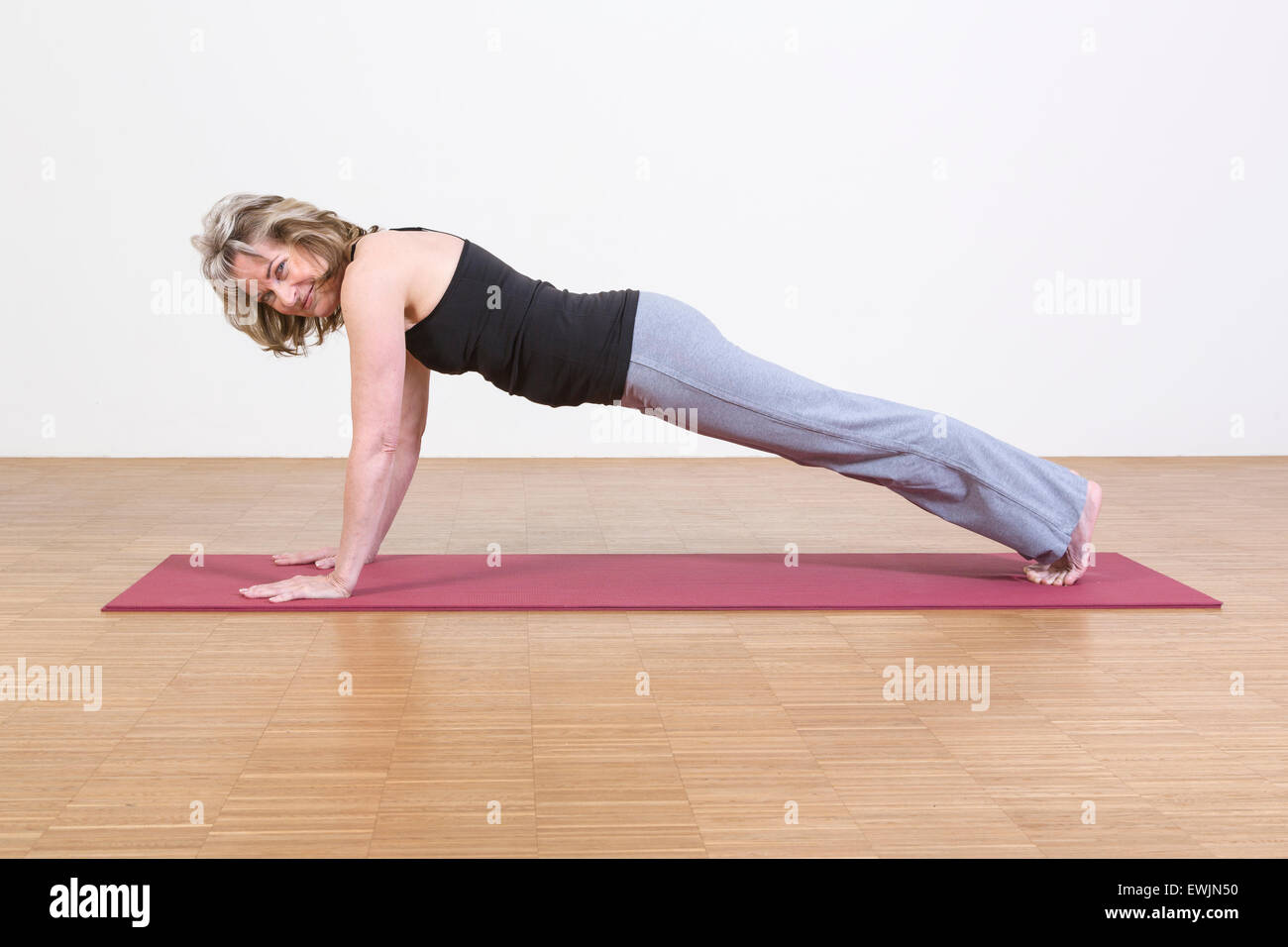female yoga coach shows exercise Stock Photo - Alamy