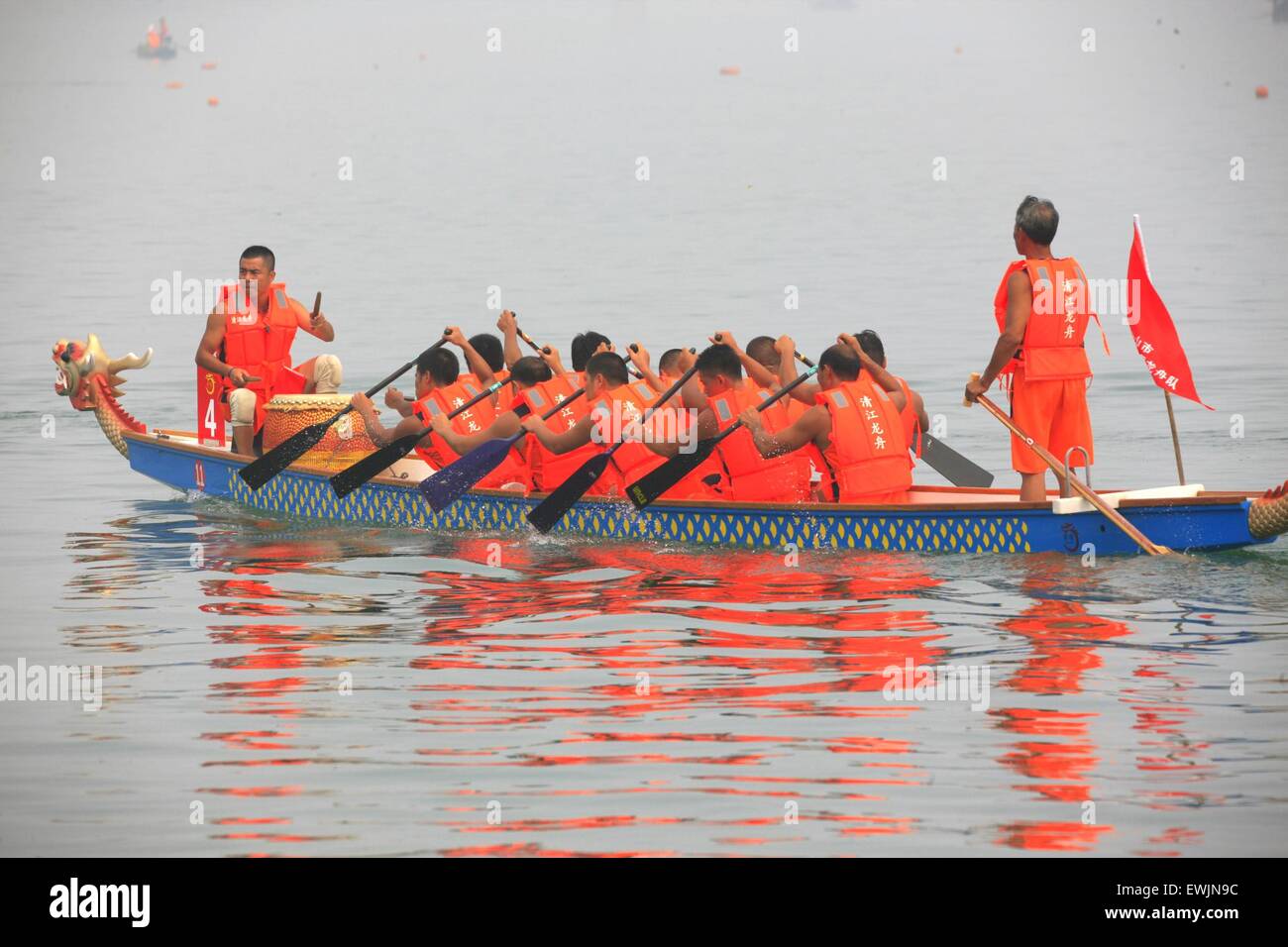 People take part in a dragon boat racing in Yangtze river in Yidu ...