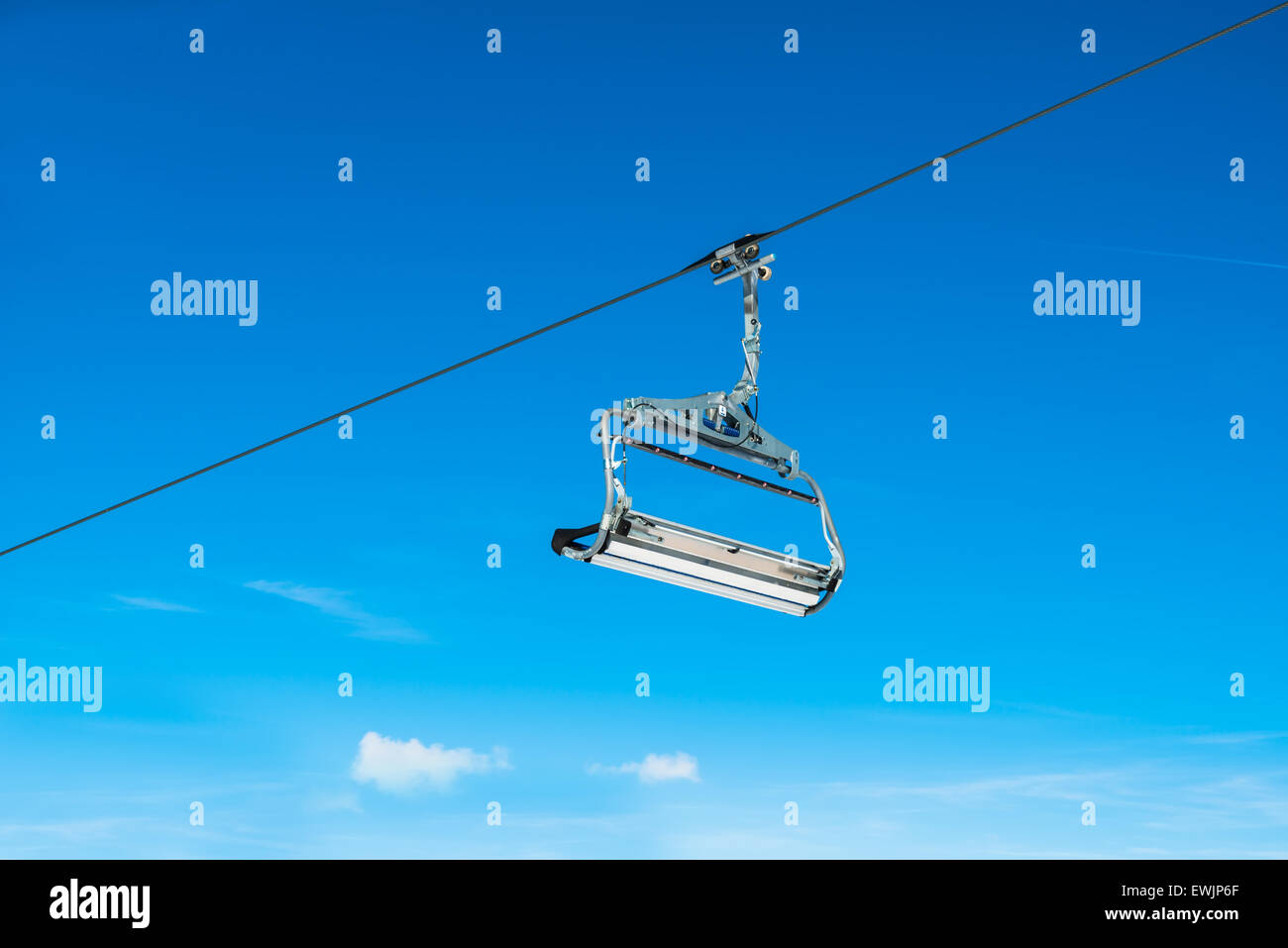 Cable ski chair against blue sky Stock Photo - Alamy