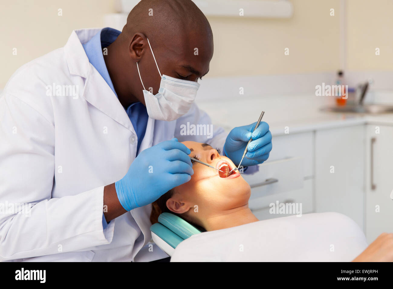 professional male dentist examining woman's teeth Stock Photo - Alamy