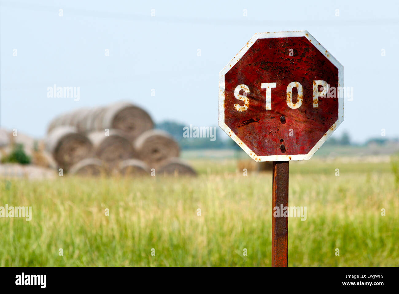 Rural shabby simple stop sign next to the field Stock Photo - Alamy