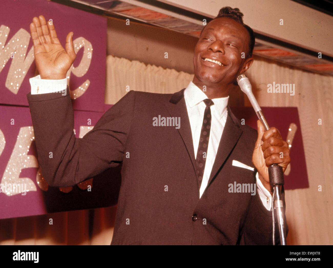NAT KING COLE (1919-1965) US singer at a London reception in 1964 ...