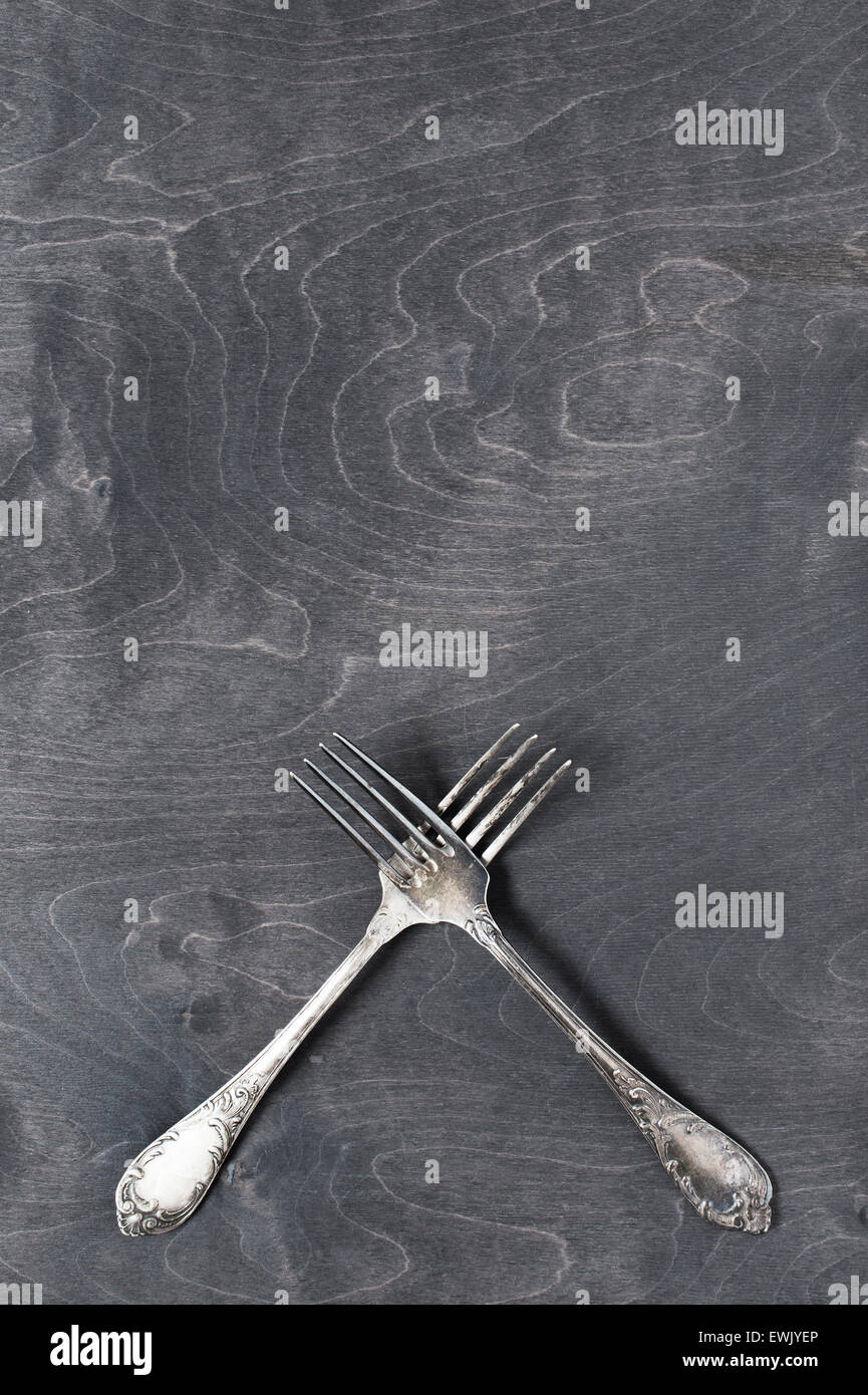 Cutlery setting on the dark wooden table Stock Photo - Alamy