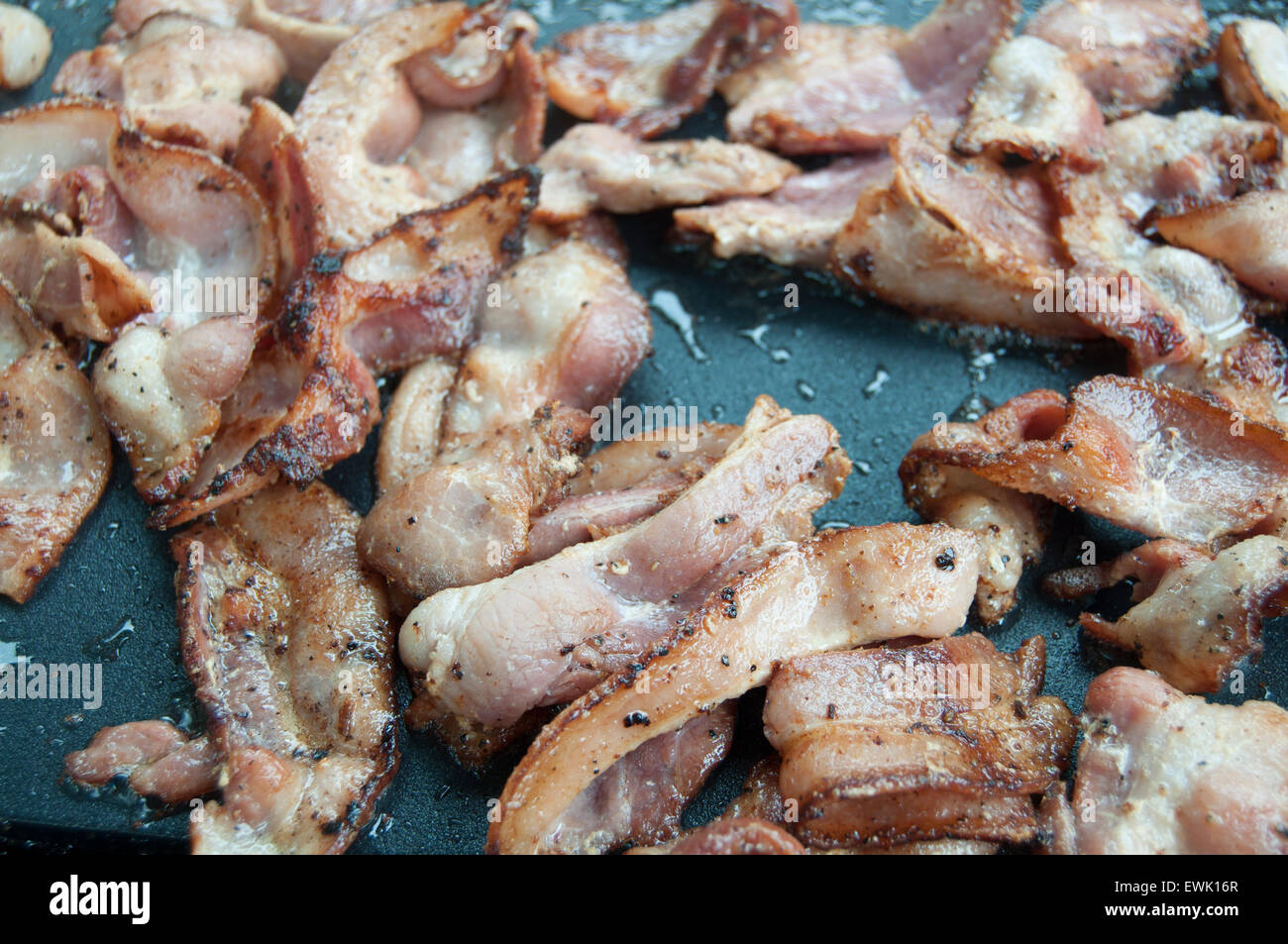Bacon frying on a grill Stock Photo - Alamy