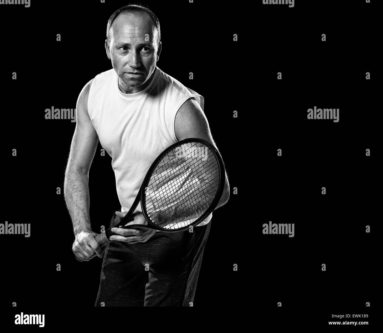 Adult male tennis player. Studio shot over black Stock Photo - Alamy