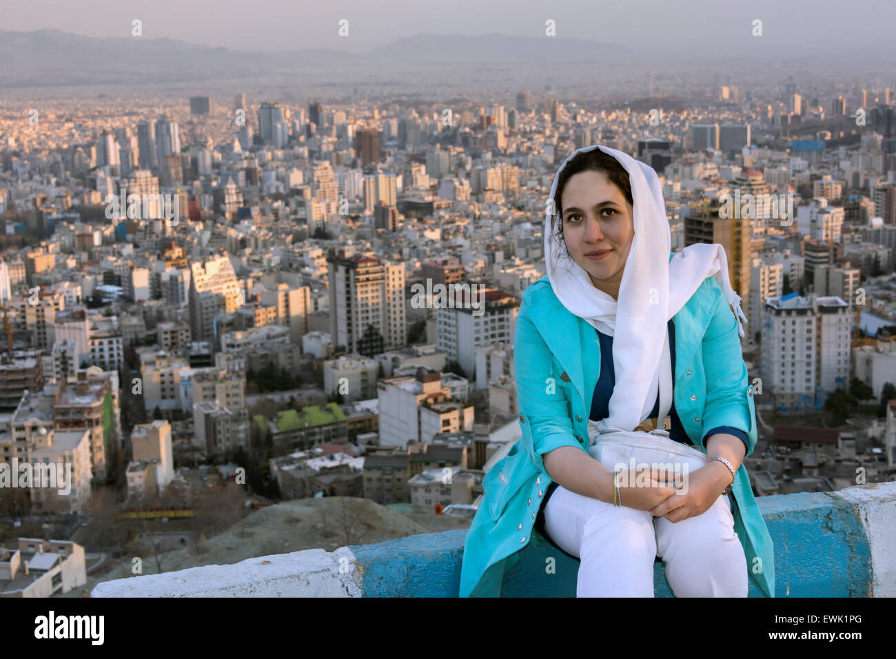 Persian woman at sunset posing with city backdrop, Tehran, Iran Stock ...