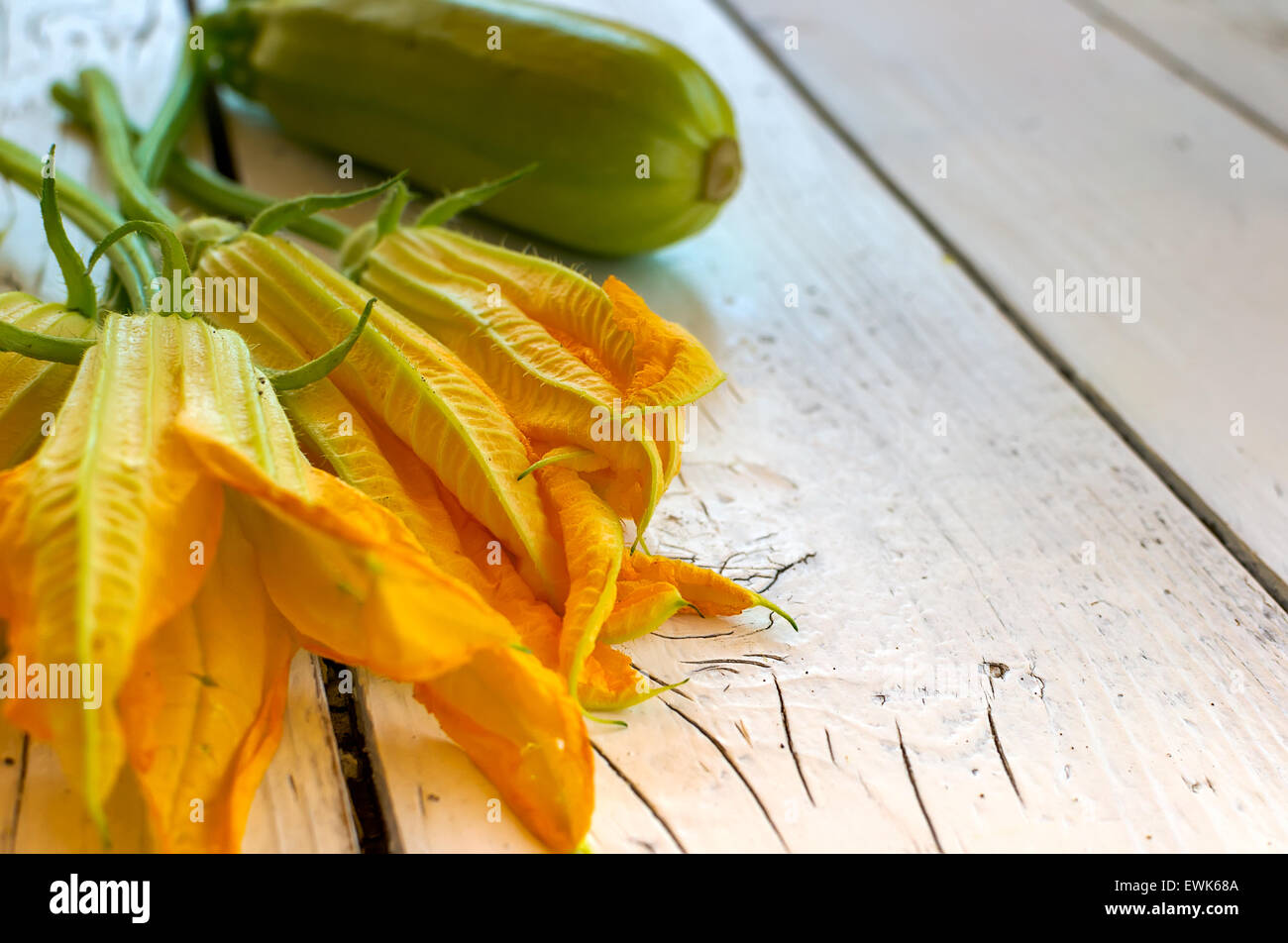 Edible flowers of courgettes and courgettes on a white table Stock ...