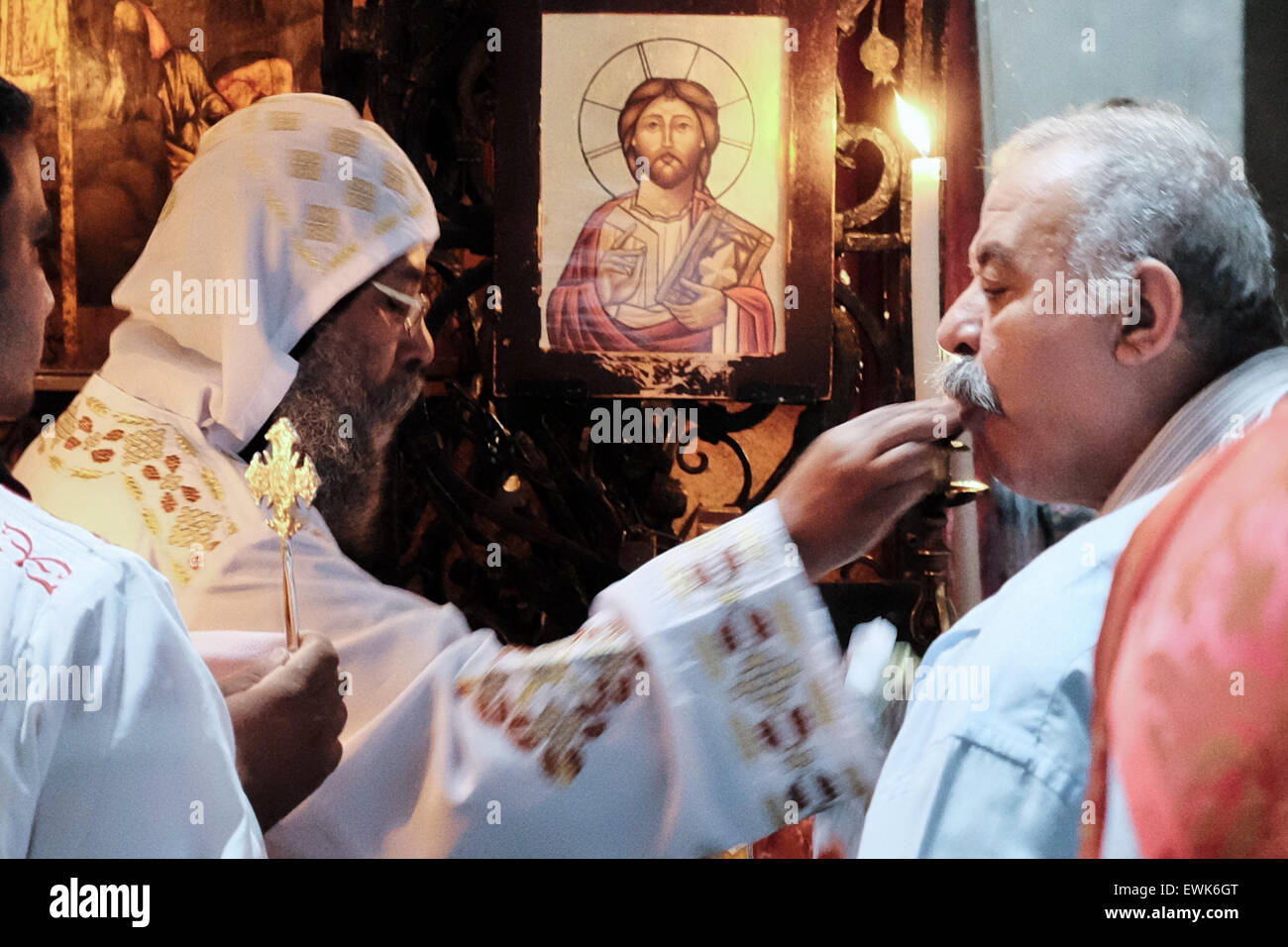 Jerusalem, Israel. 28th June, 2015. A Coptic priest places communion ...