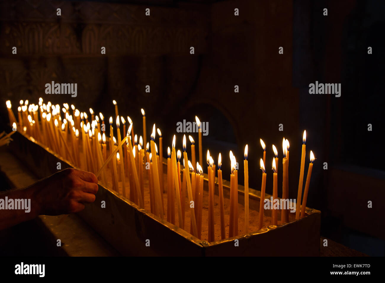 Rows of burning candles in a dim church Stock Photo - Alamy