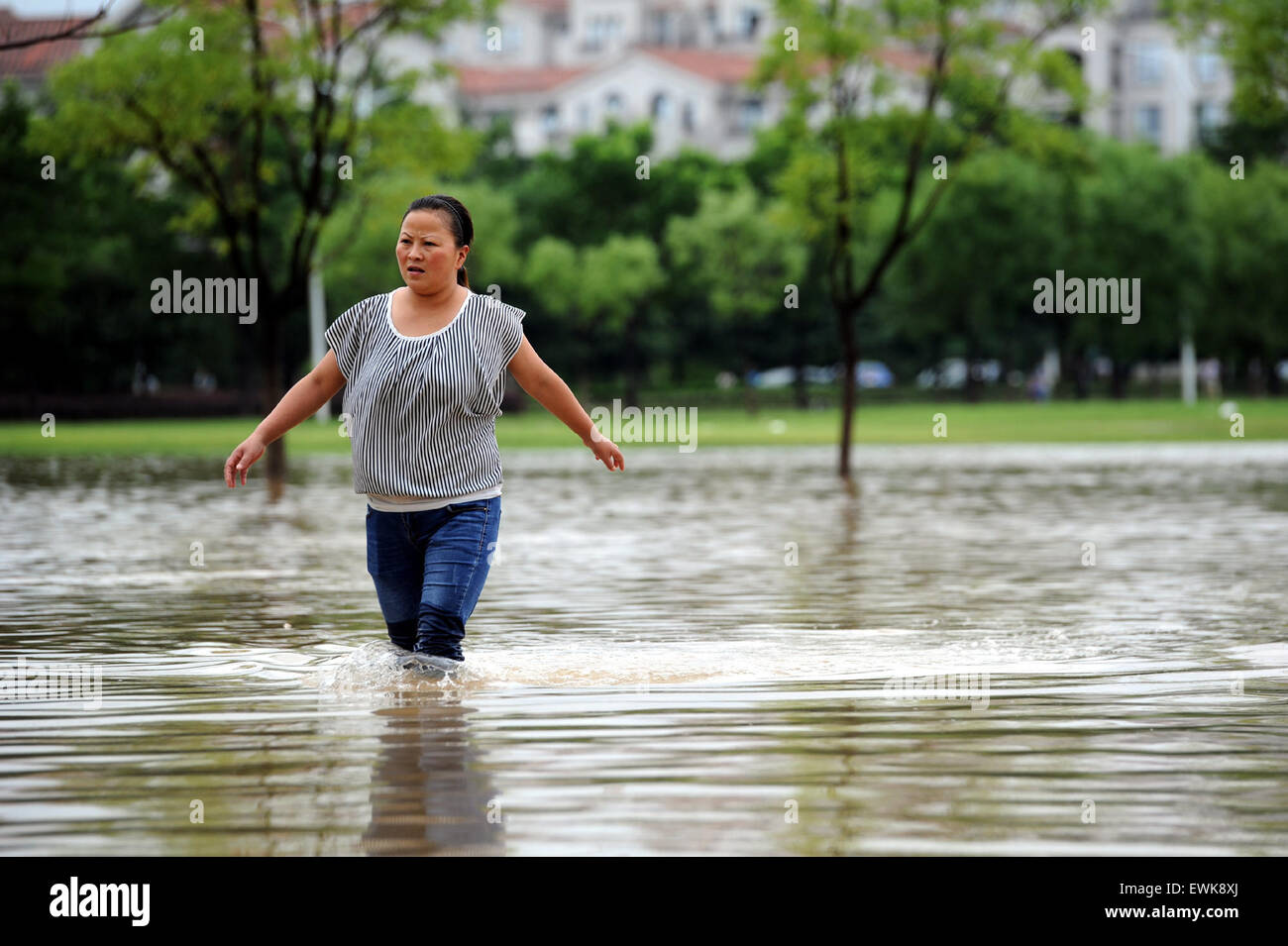 Nanjing, China's Jiangsu Province. 28th June, 2015. A woman walks in a ...