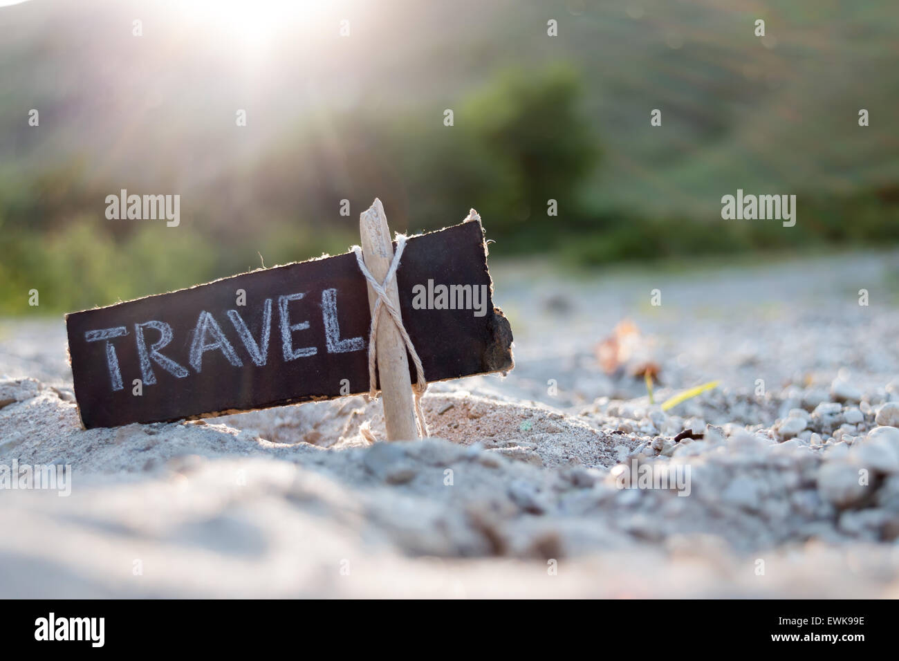 Travel concept. Sign with the word travel on the beach Stock Photo - Alamy