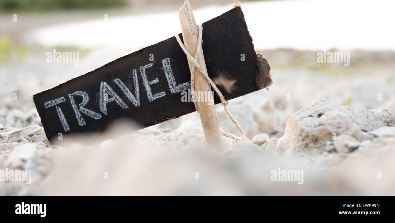 Travel concept. Sign with the word travel on the beach Stock Photo - Alamy