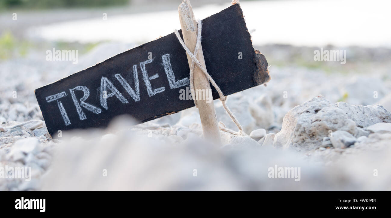 Travel concept. Sign with the word travel on the beach Stock Photo - Alamy