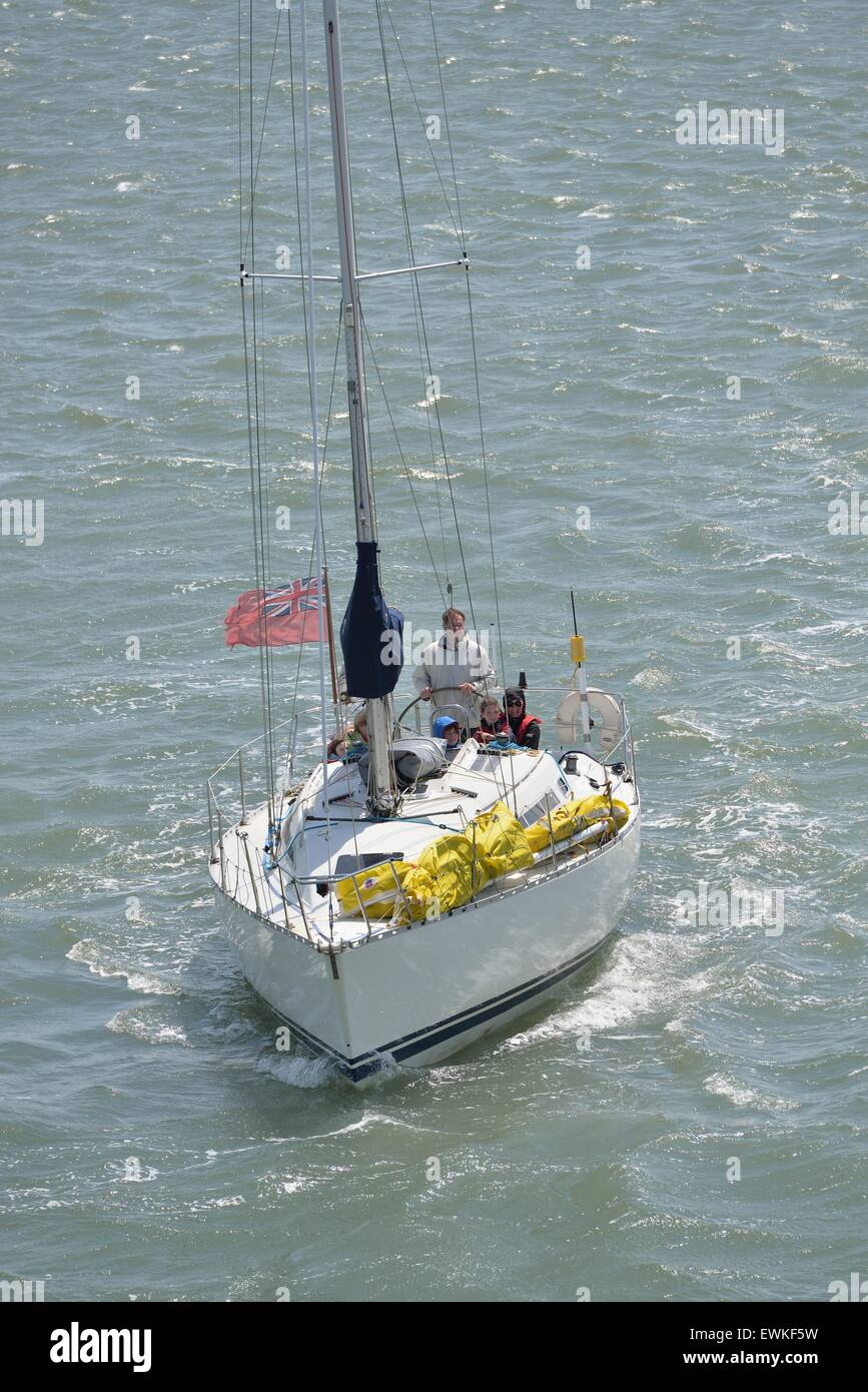 Sailing yacht motoring from harbour to sea in the Solent, England, UK ...