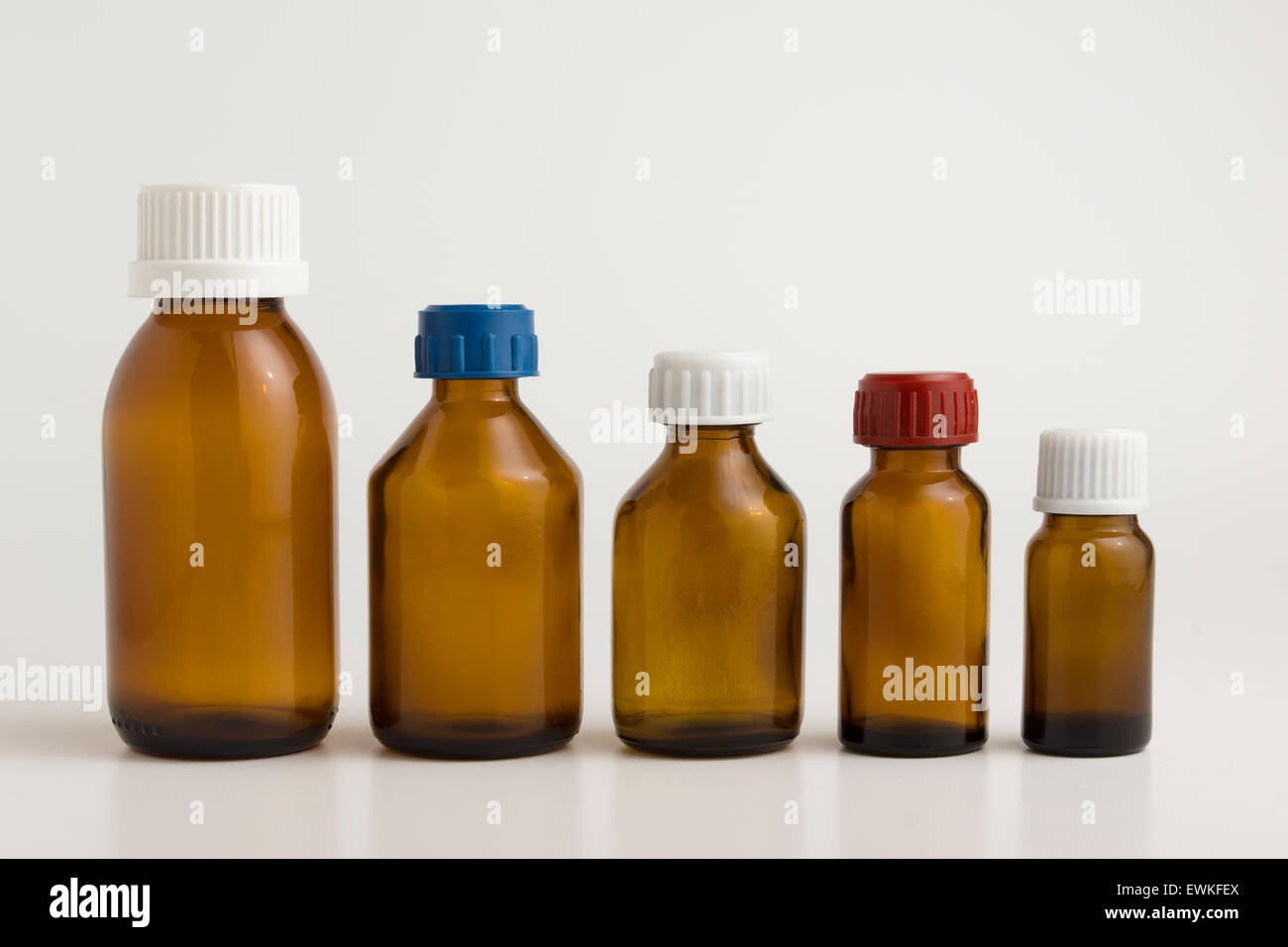 many medical bottles with caps on a white background Stock Photo - Alamy