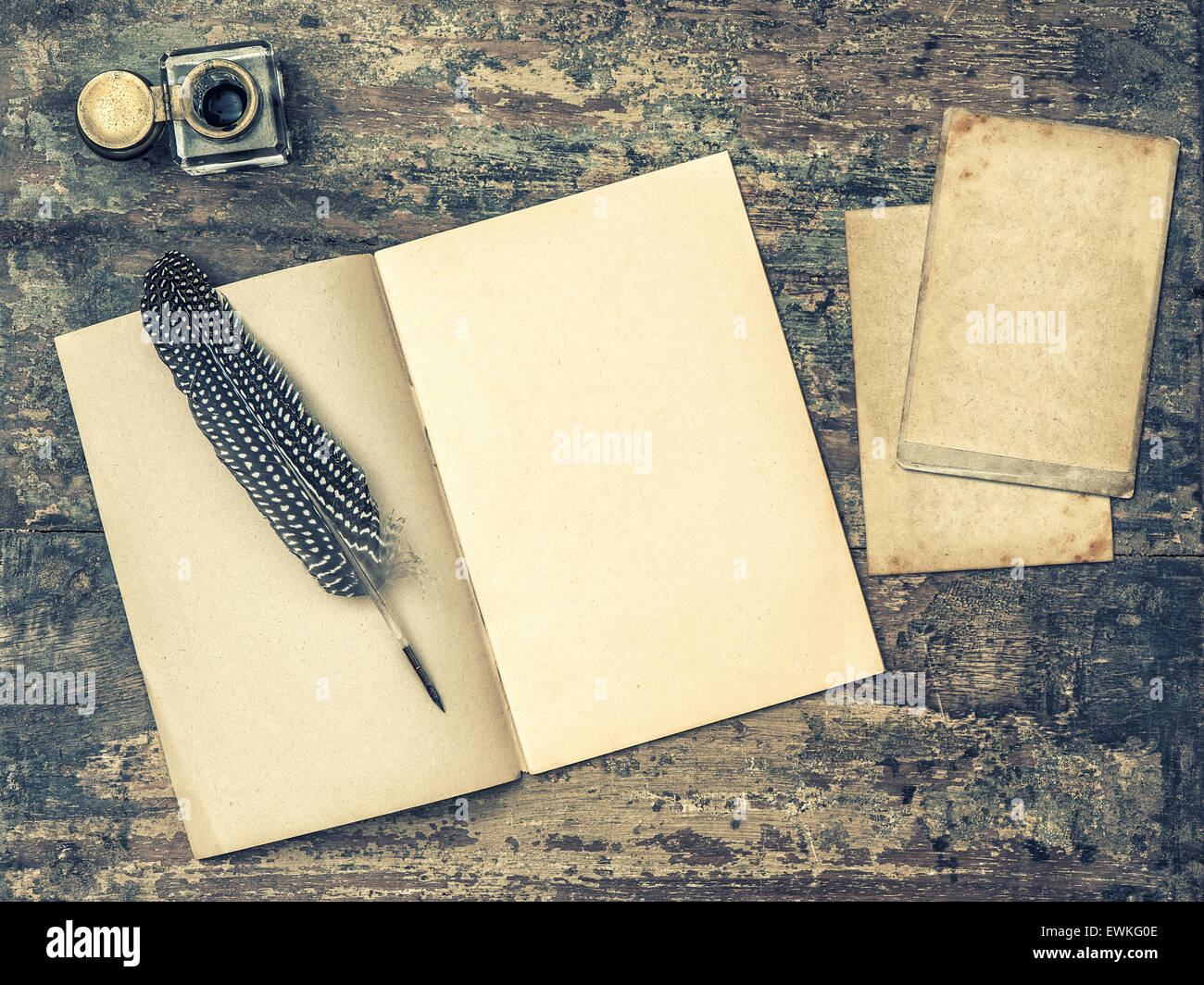 Open book, antique writing tools feather pen and inkwell on textured ...
