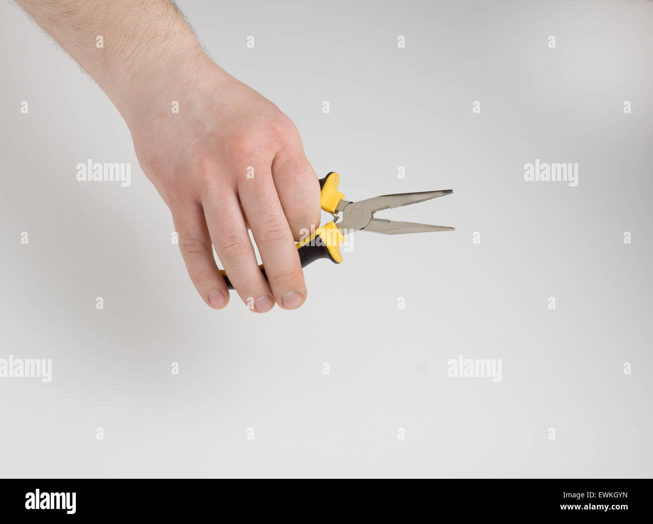 the human hand holds the pliers on a white background Stock Photo - Alamy
