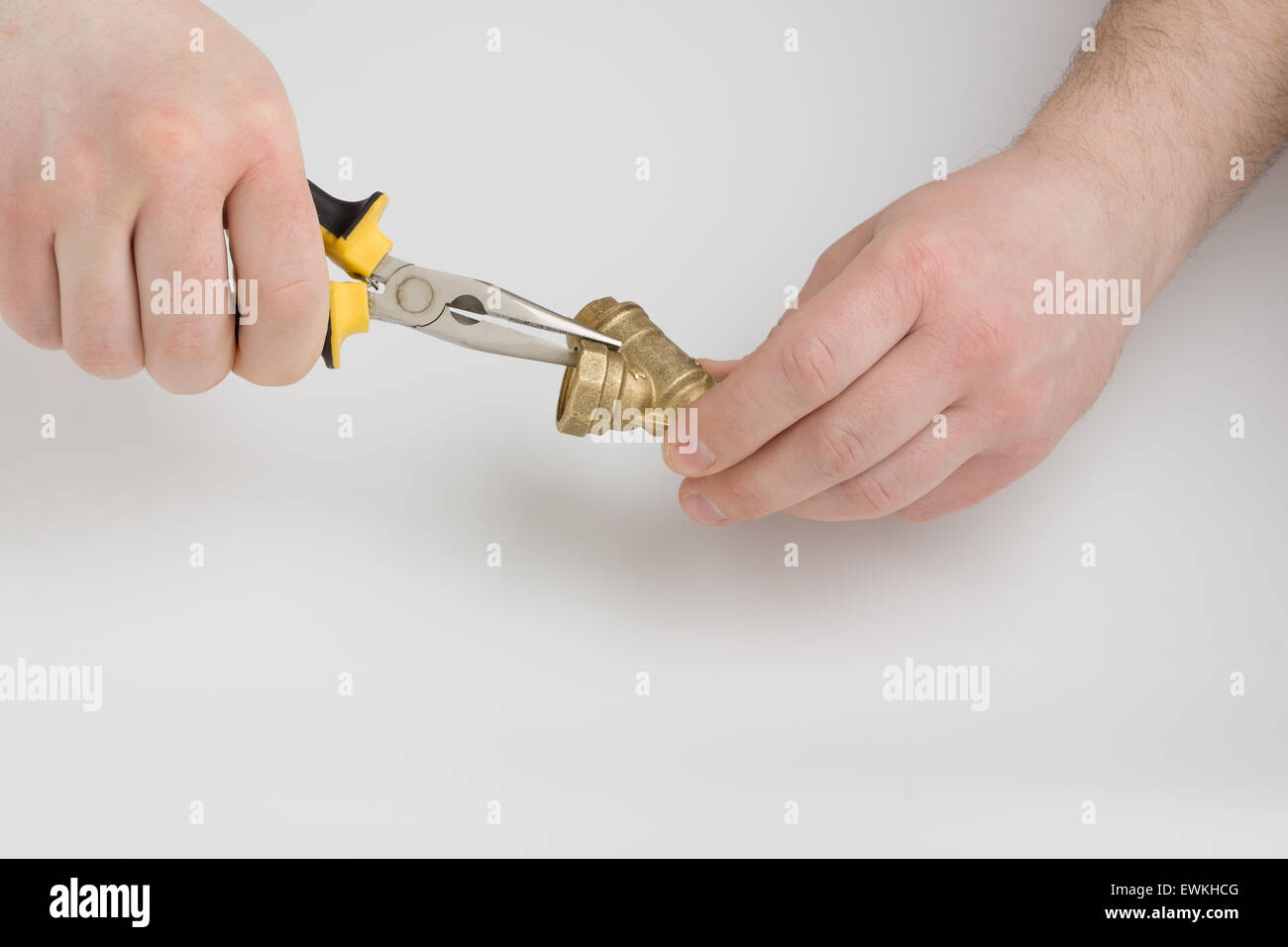 the human hand holds the pliers on a white background Stock Photo - Alamy